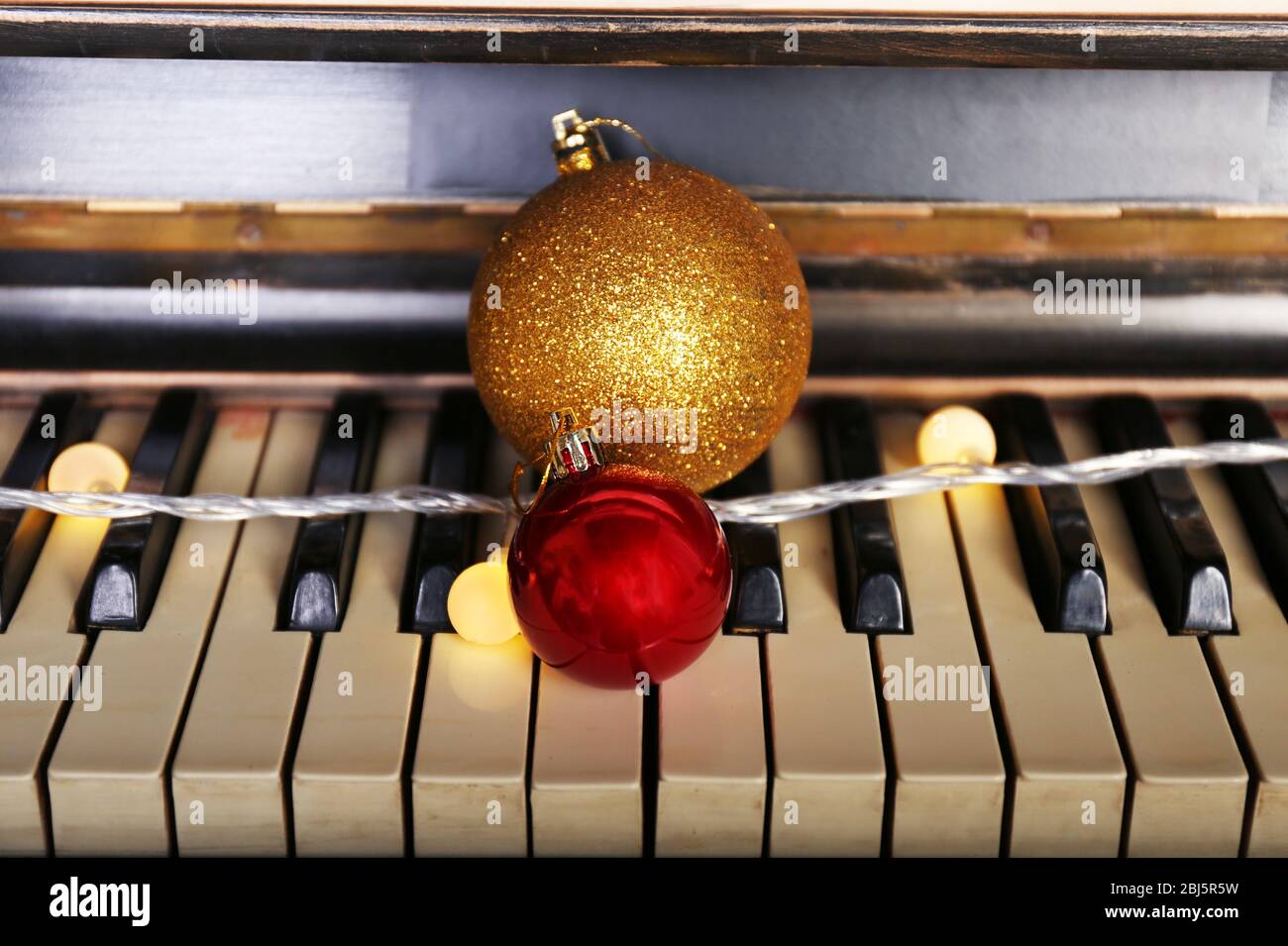Piano keys decorated with decorative lights and balls, close up Stock ...