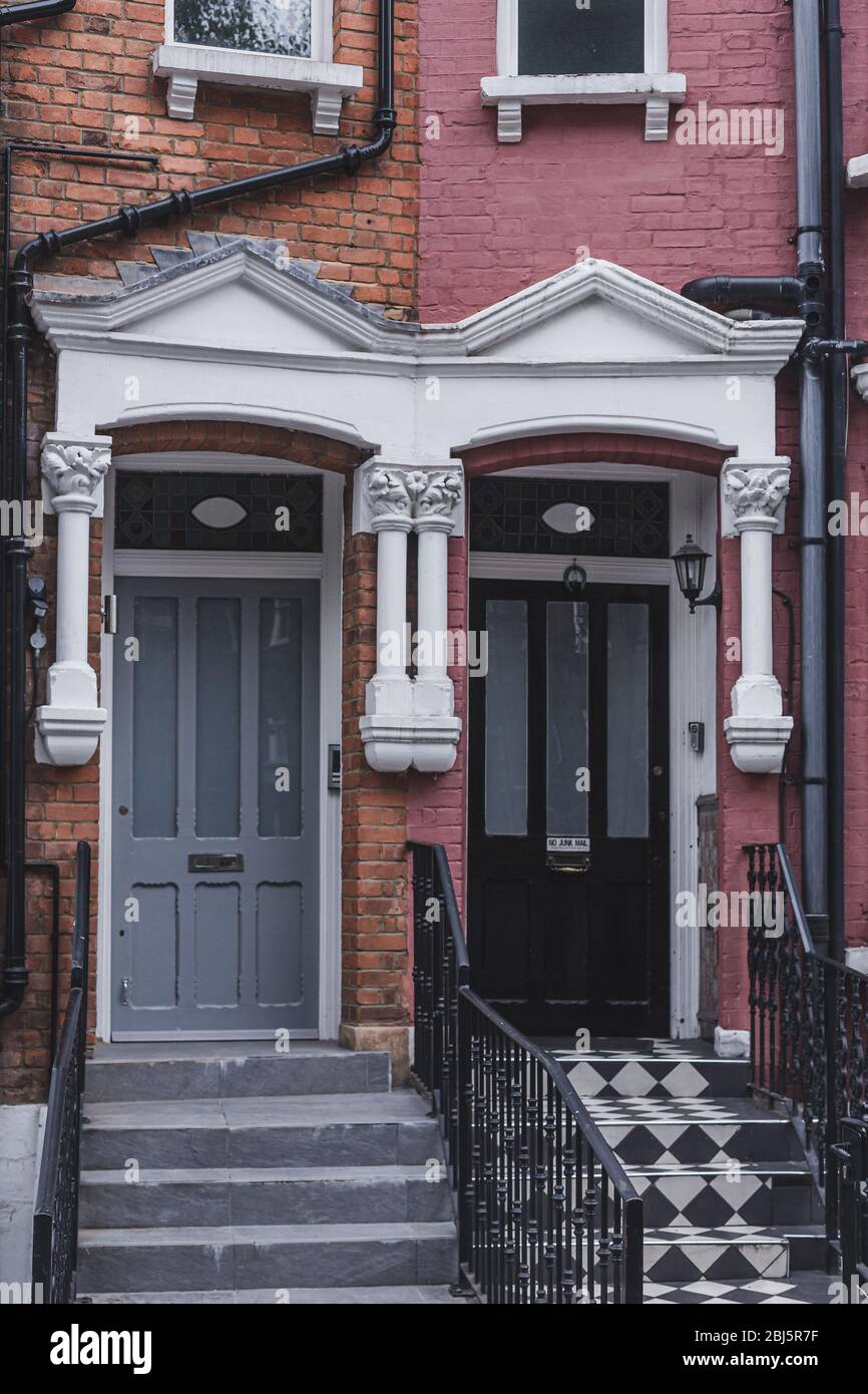Black and grey entrance doors on a facade of traditional English ...