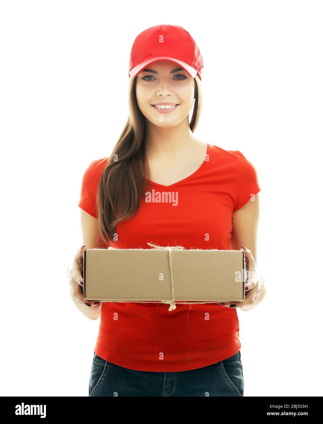Delivery woman in red uniform holding package isolated on white ...