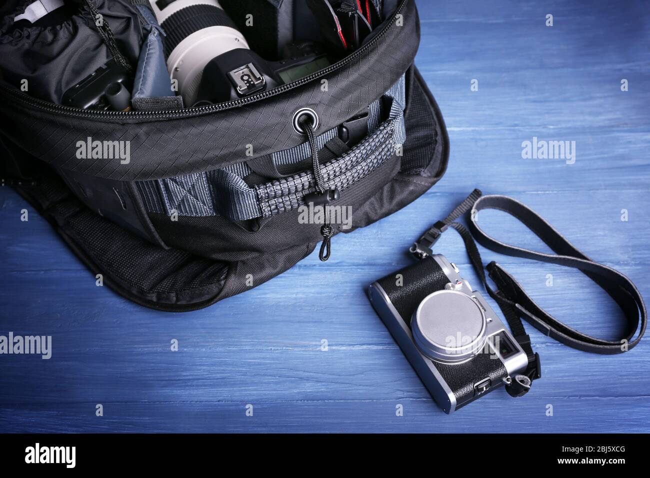 Photographer's equipment on a dark blue background Stock Photo - Alamy