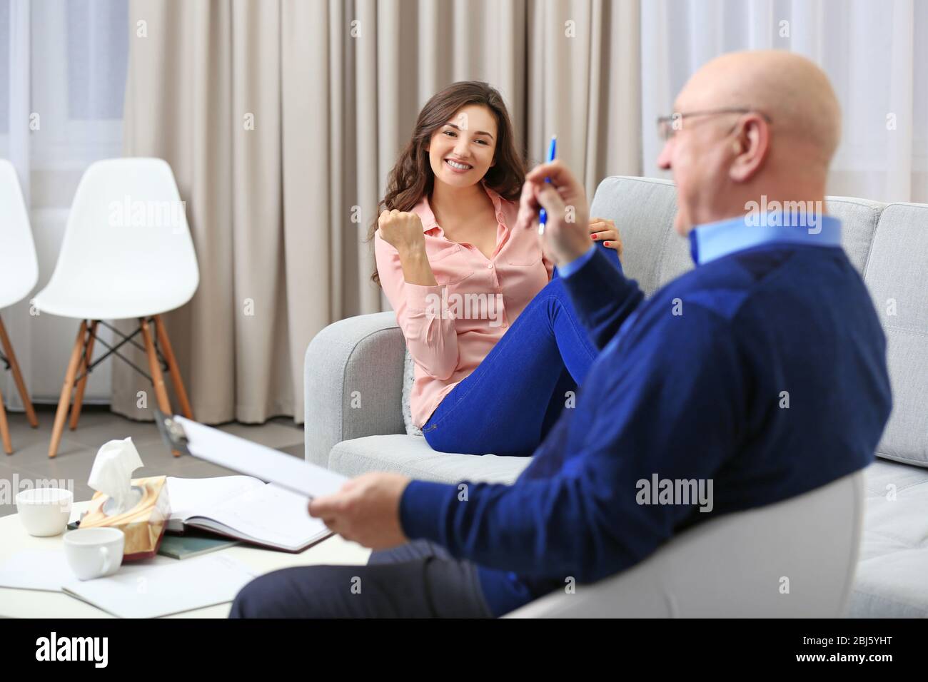Young woman on reception at psychologist Stock Photo - Alamy