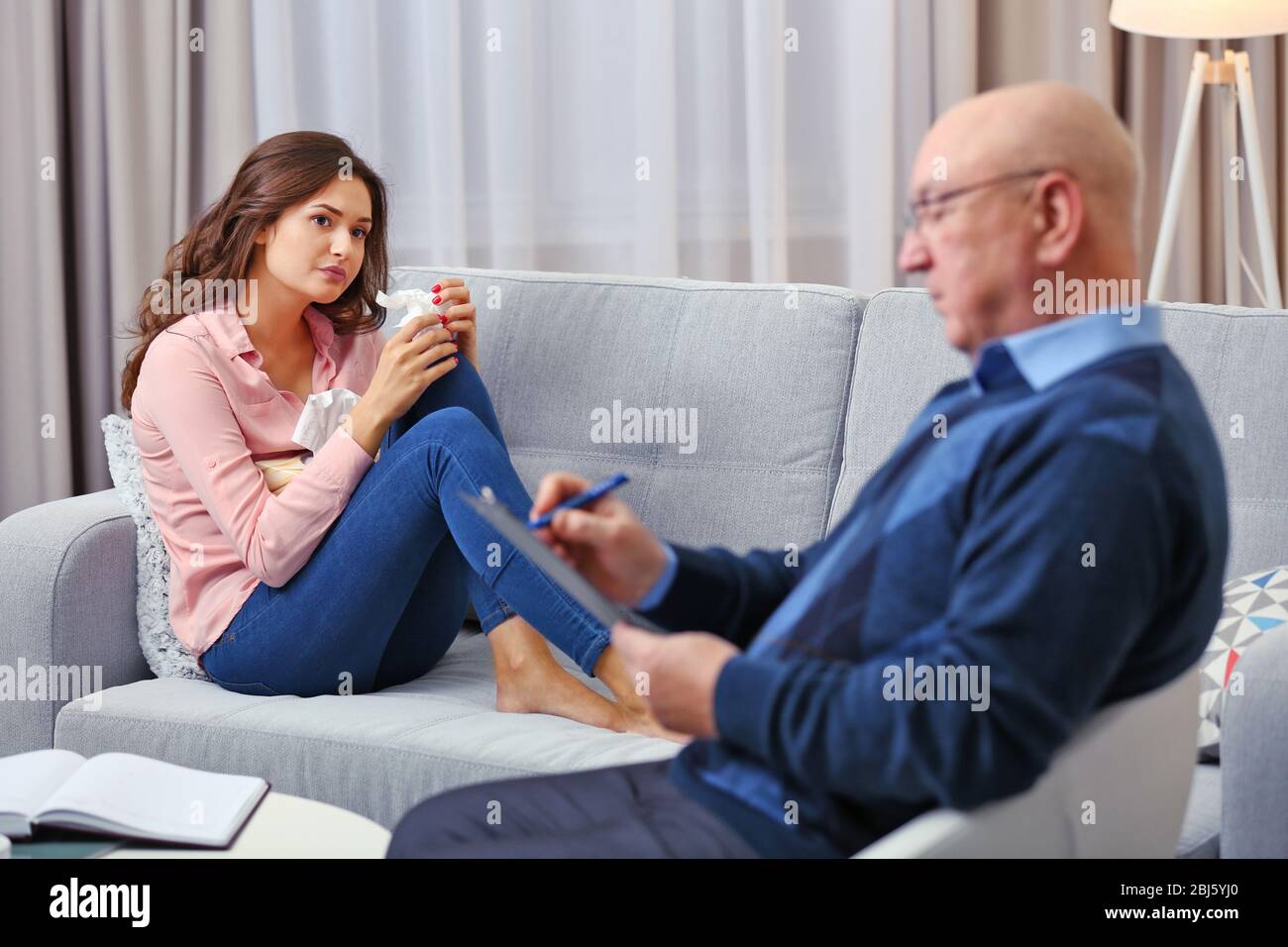 Young woman on reception at psychologist Stock Photo - Alamy