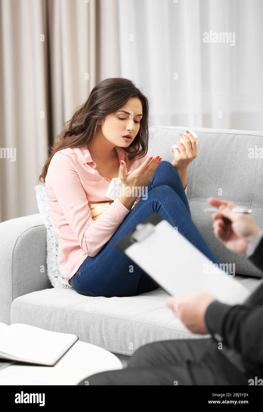 Young woman on reception at psychologist Stock Photo - Alamy