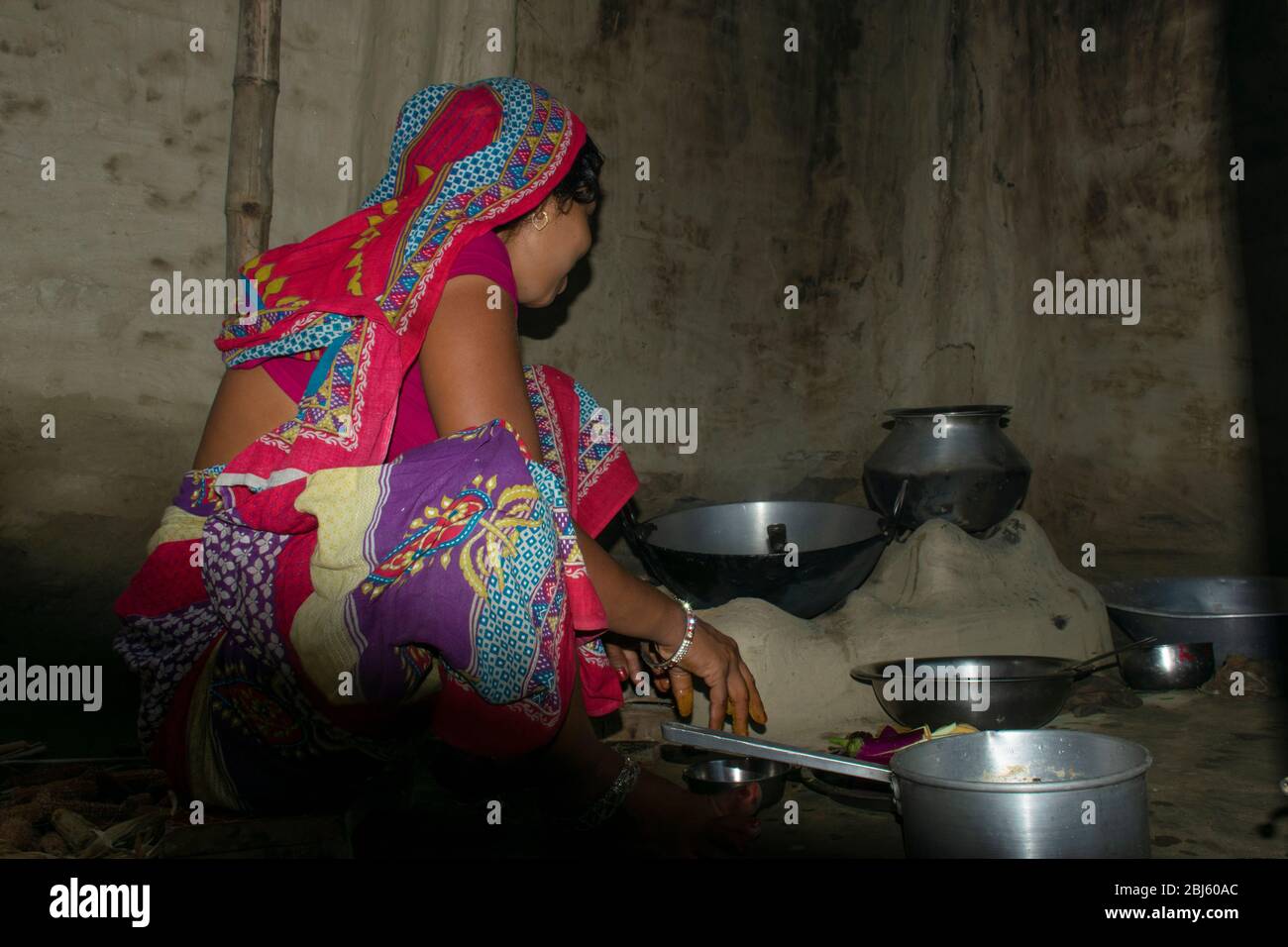 Rural Woman Cooking Food In Vintage Kitchen Using Fire Stove Chulha