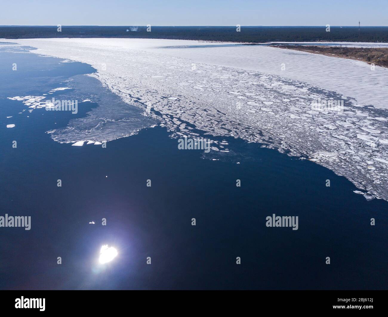 Aerial view of the border of ice broken into pieces of various shapes ...