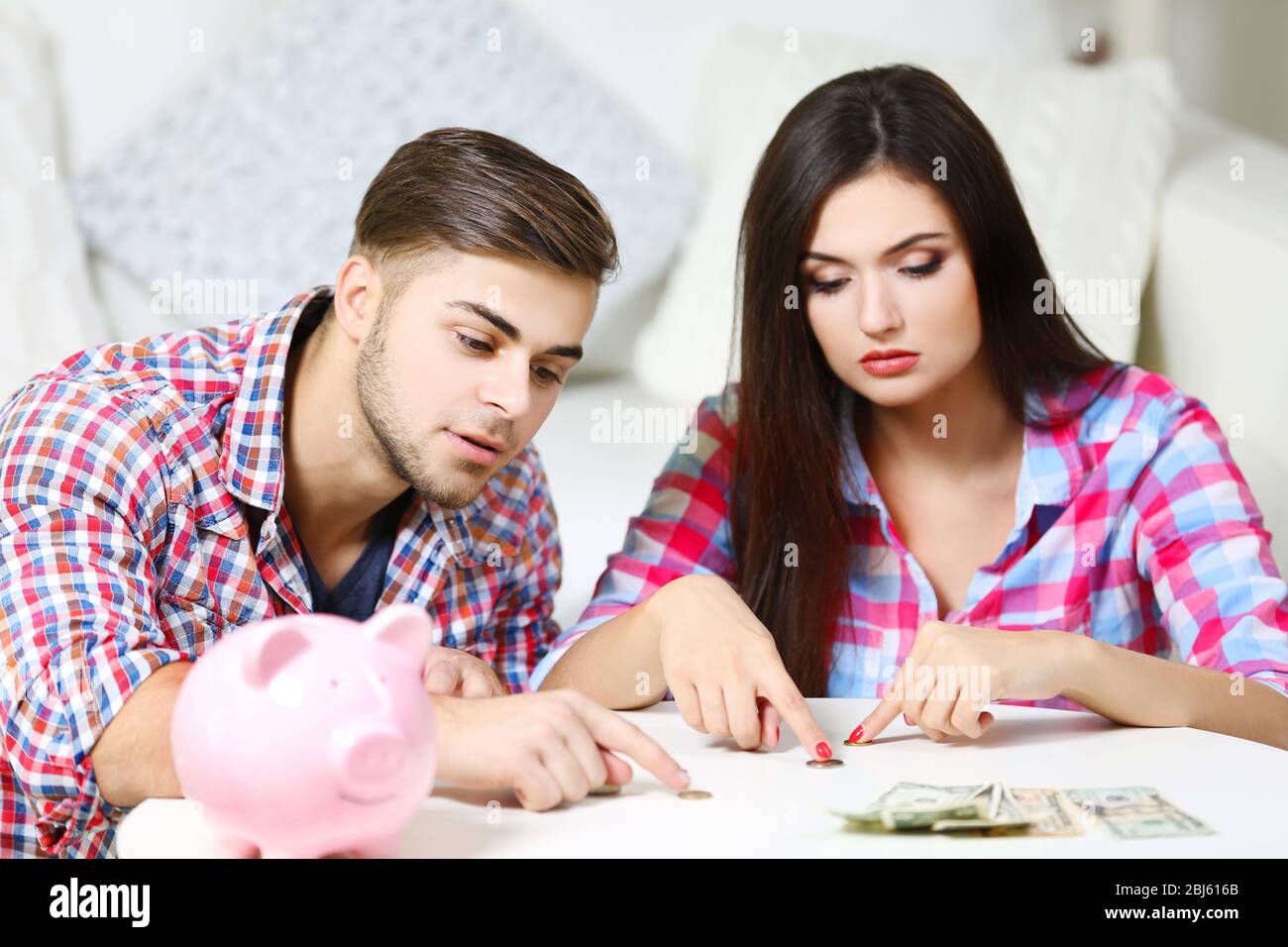 Happy couple counting money from the moneybox Stock Photo - Alamy