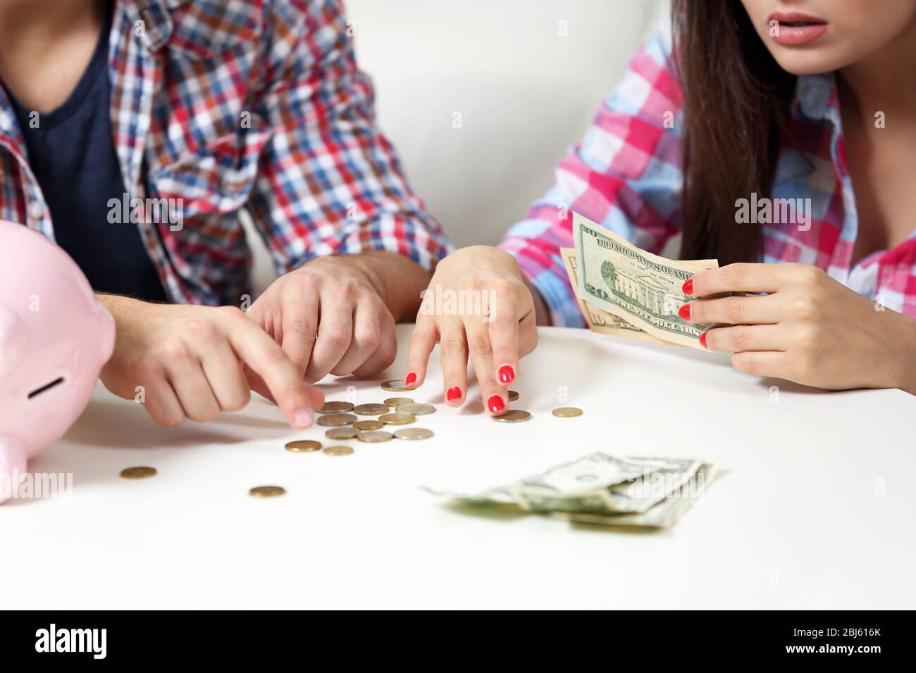 Happy couple counting money from the moneybox Stock Photo - Alamy