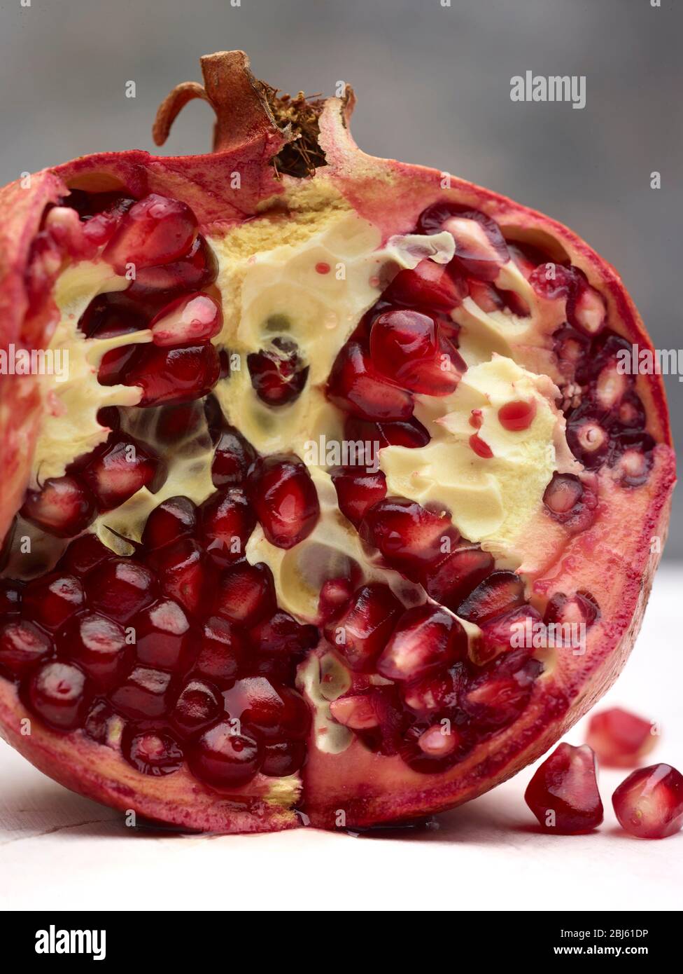 Close-up pomegranate fruit (food) portrait showing seeds prominently ...