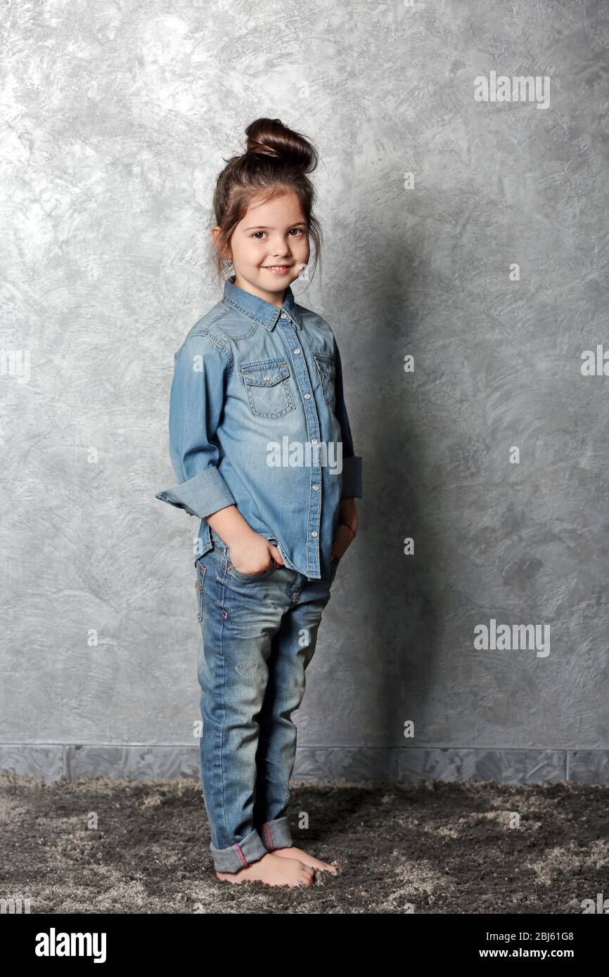 Portrait of little fashion kid girl on gray wall background Stock Photo ...