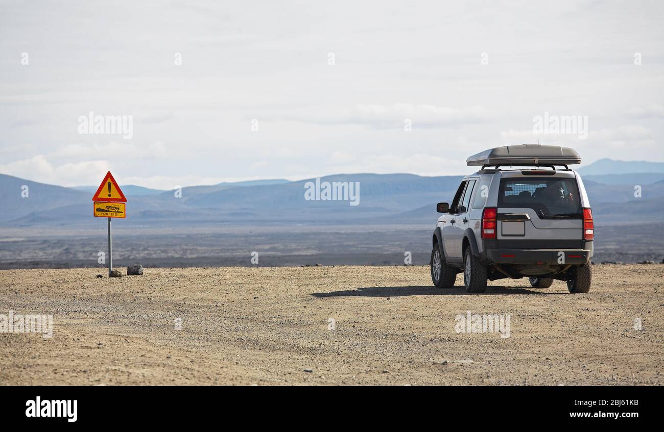 SUV stopped in front of traffic sign in the highlands of Iceland Stock ...