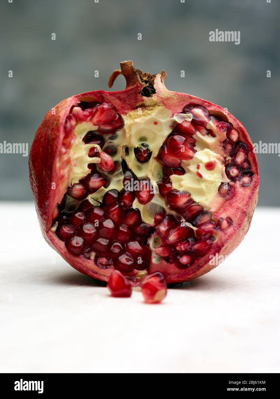 Close-up pomegranate fruit (food) portrait showing seeds prominently ...