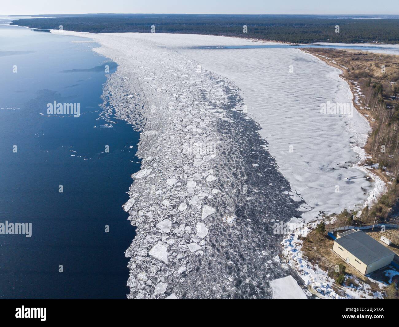 Aerial view of the shoreline of the lake and pieces of melting ice ...