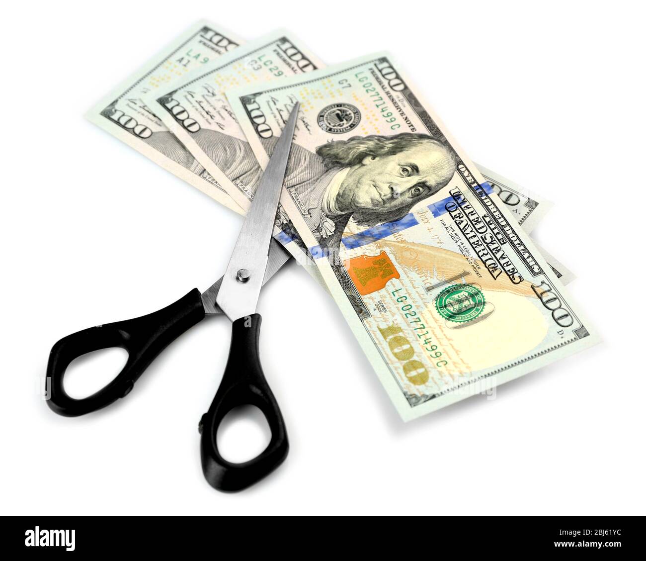 Scissors cut dollar banknotes, isolated on white Stock Photo - Alamy