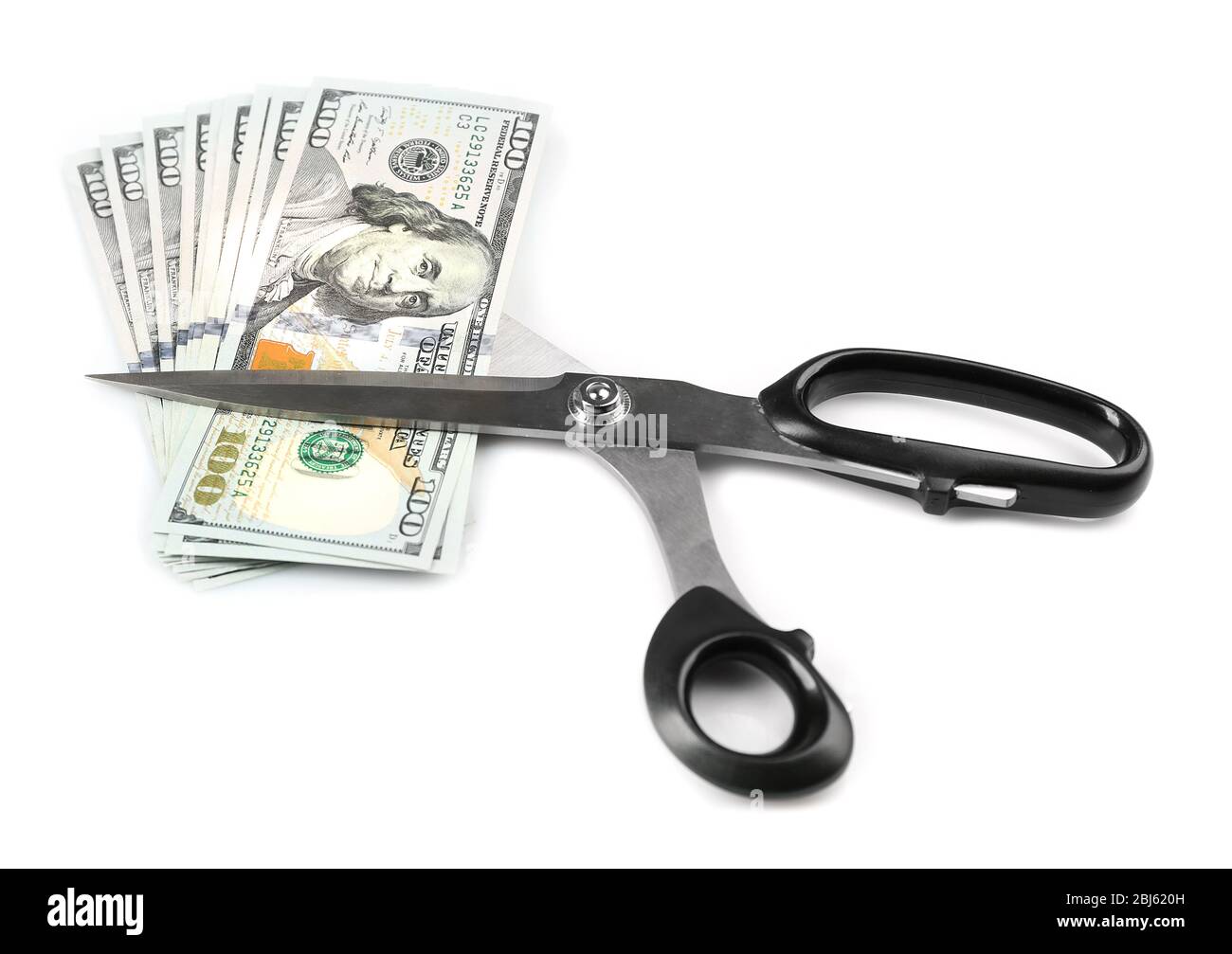 Scissors cut dollar banknotes, isolated on white Stock Photo - Alamy