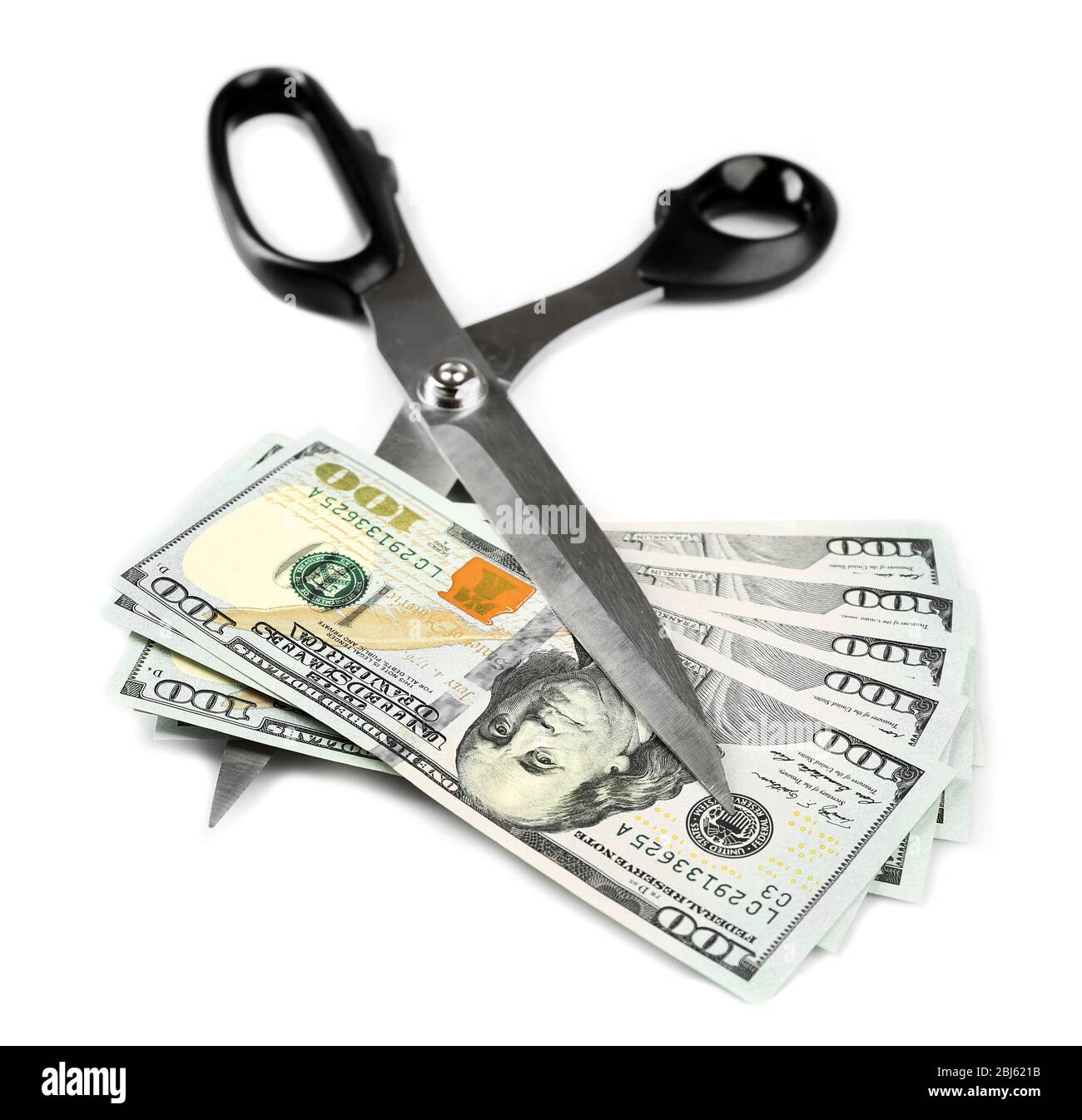 Scissors cut dollar banknotes, isolated on white Stock Photo - Alamy