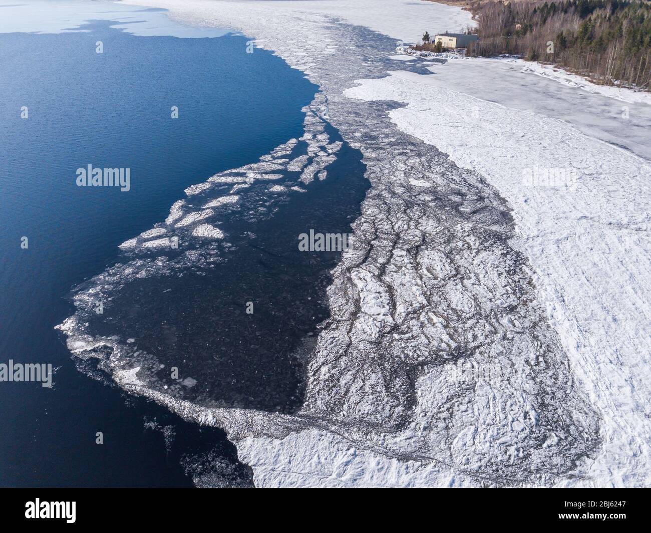 Aerial view of the shoreline of the lake and pieces of melting ice ...