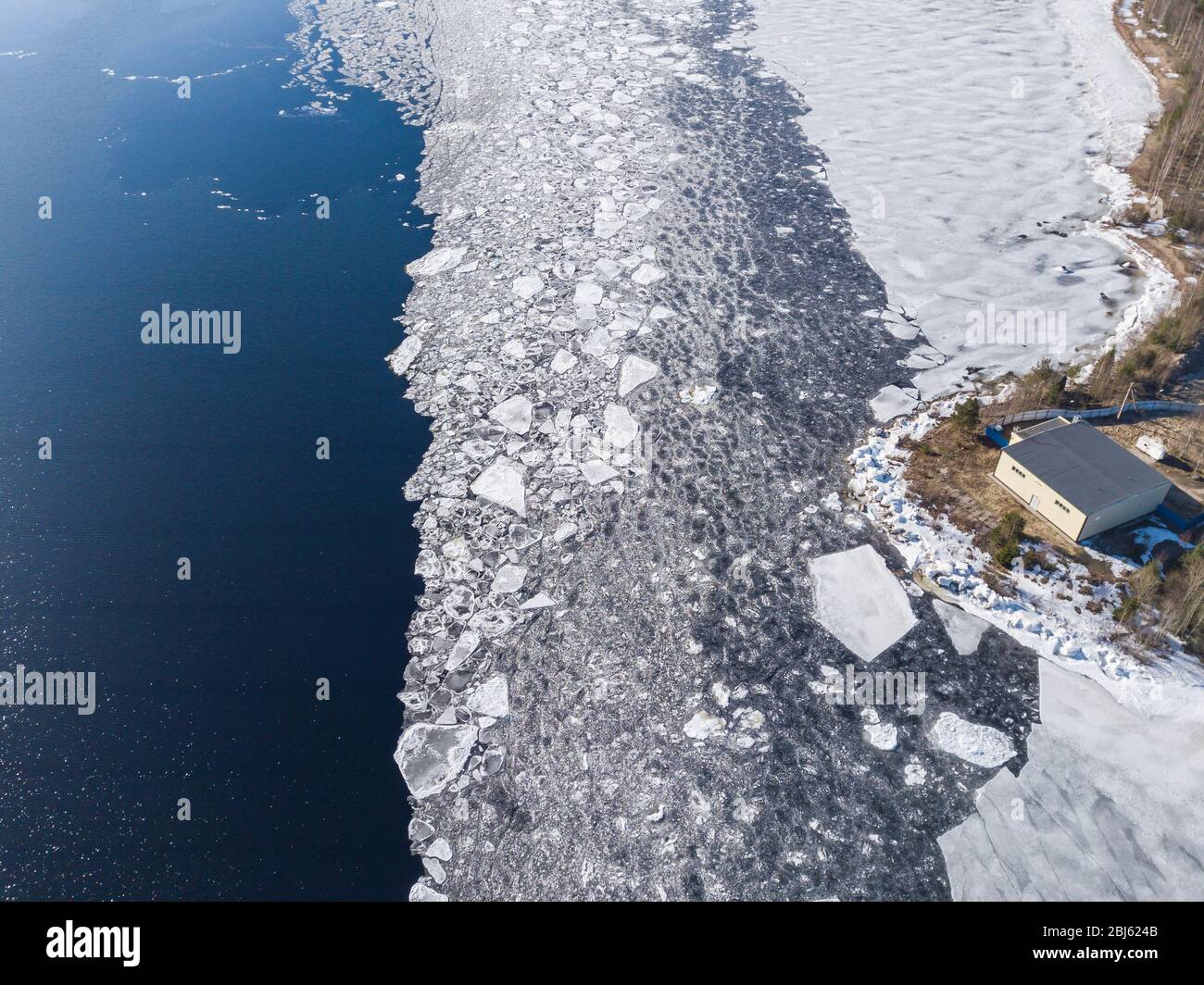 Aerial view of the shoreline of the lake and pieces of melting ice ...