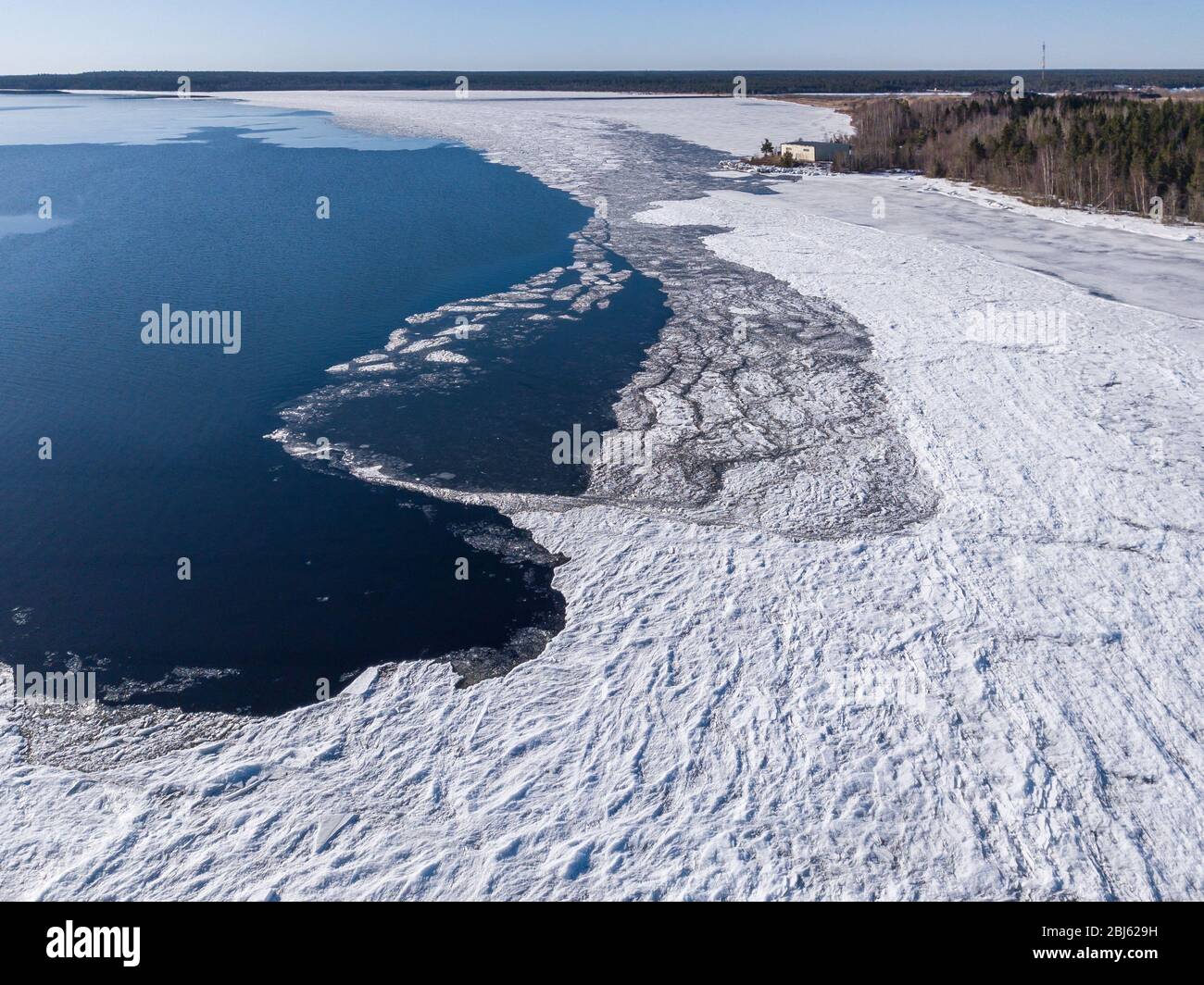Aerial view of the shoreline of the lake and pieces of melting ice ...