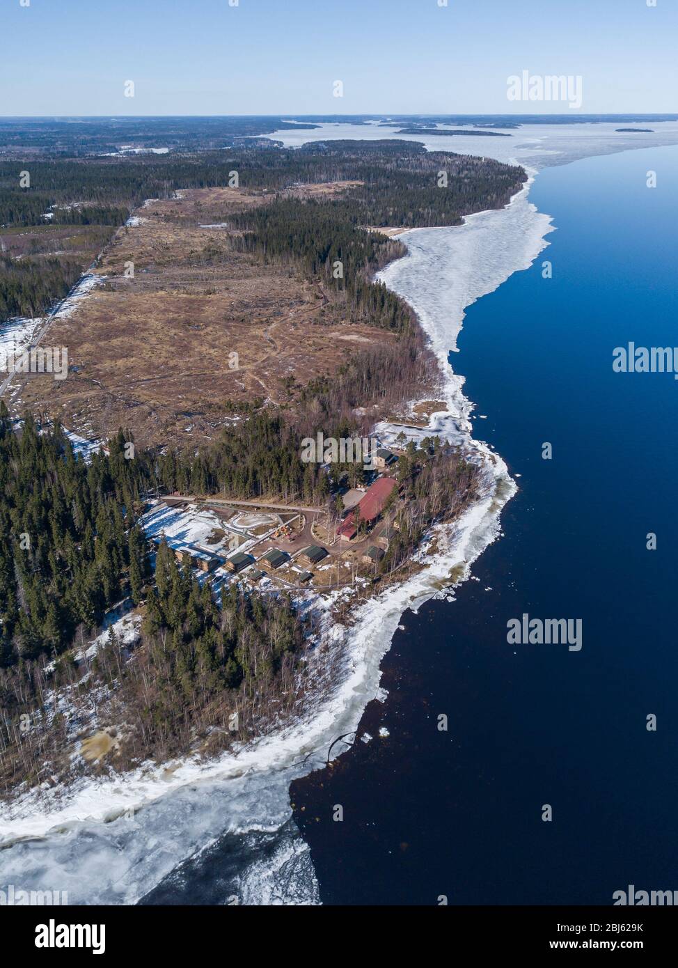 Aerial view of the shoreline of the lake and pieces of melting ice ...