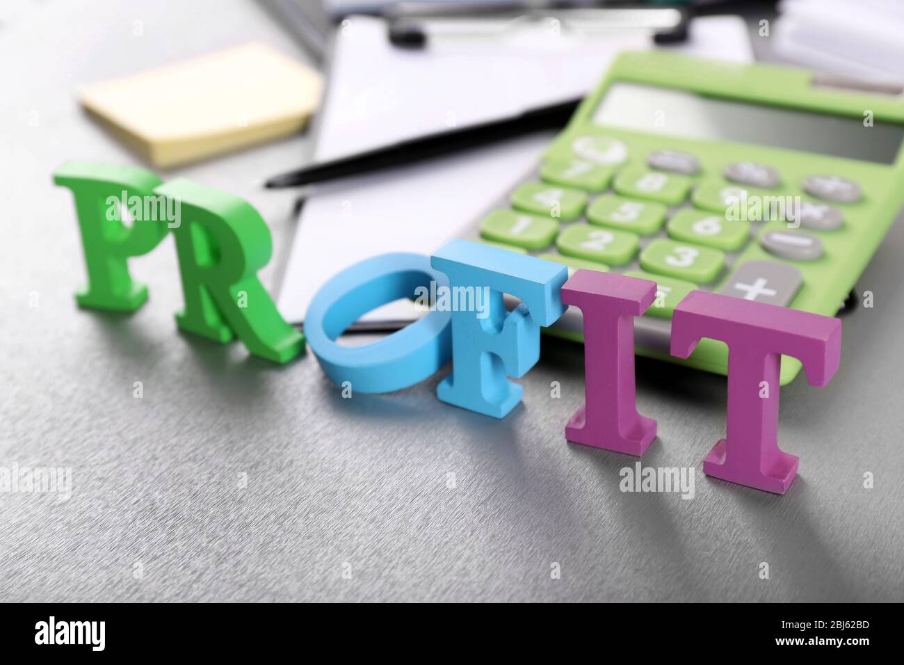 Alphabet Profit and calculator on table Stock Photo - Alamy