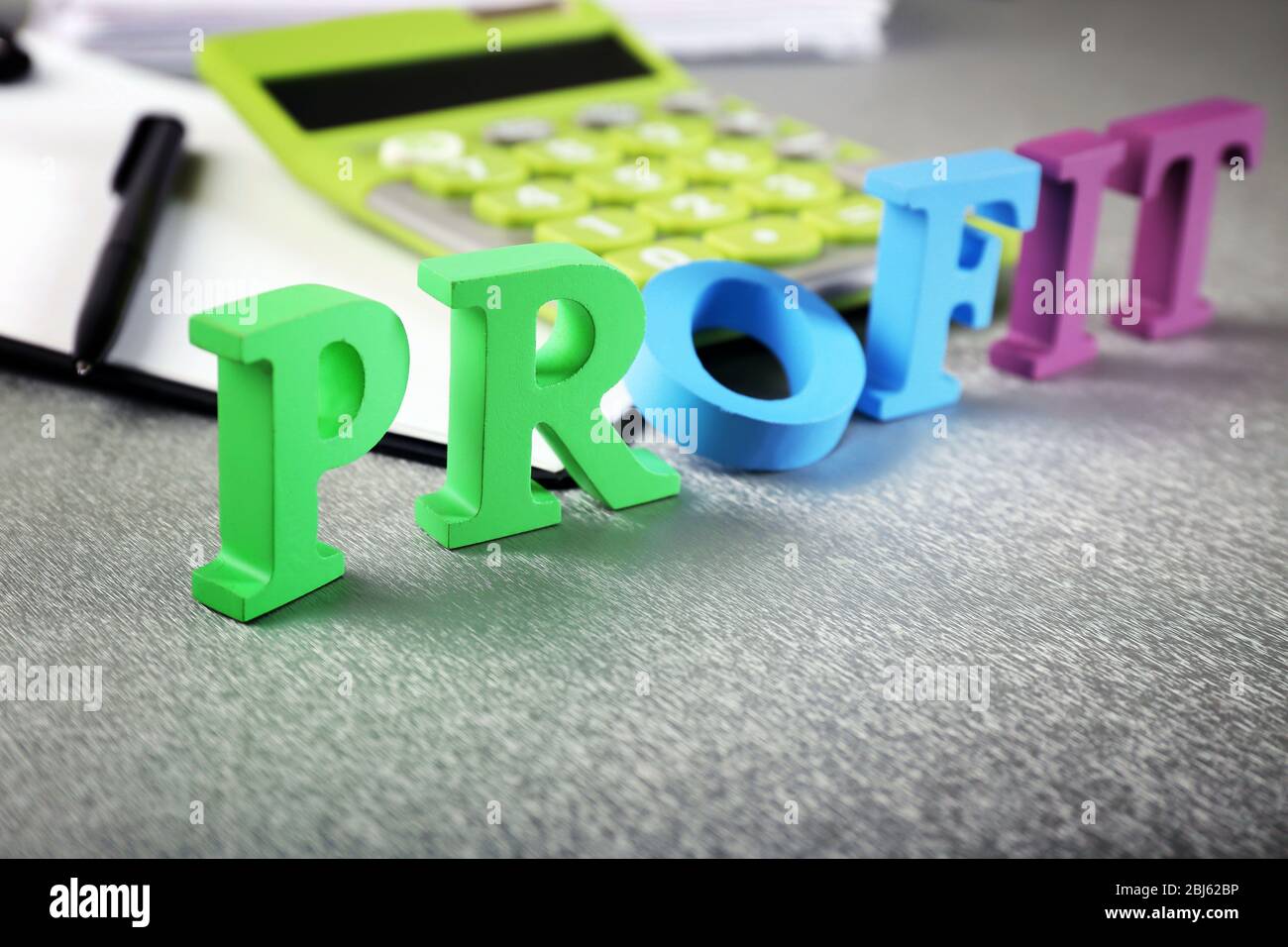 Alphabet Profit and calculator on table Stock Photo - Alamy