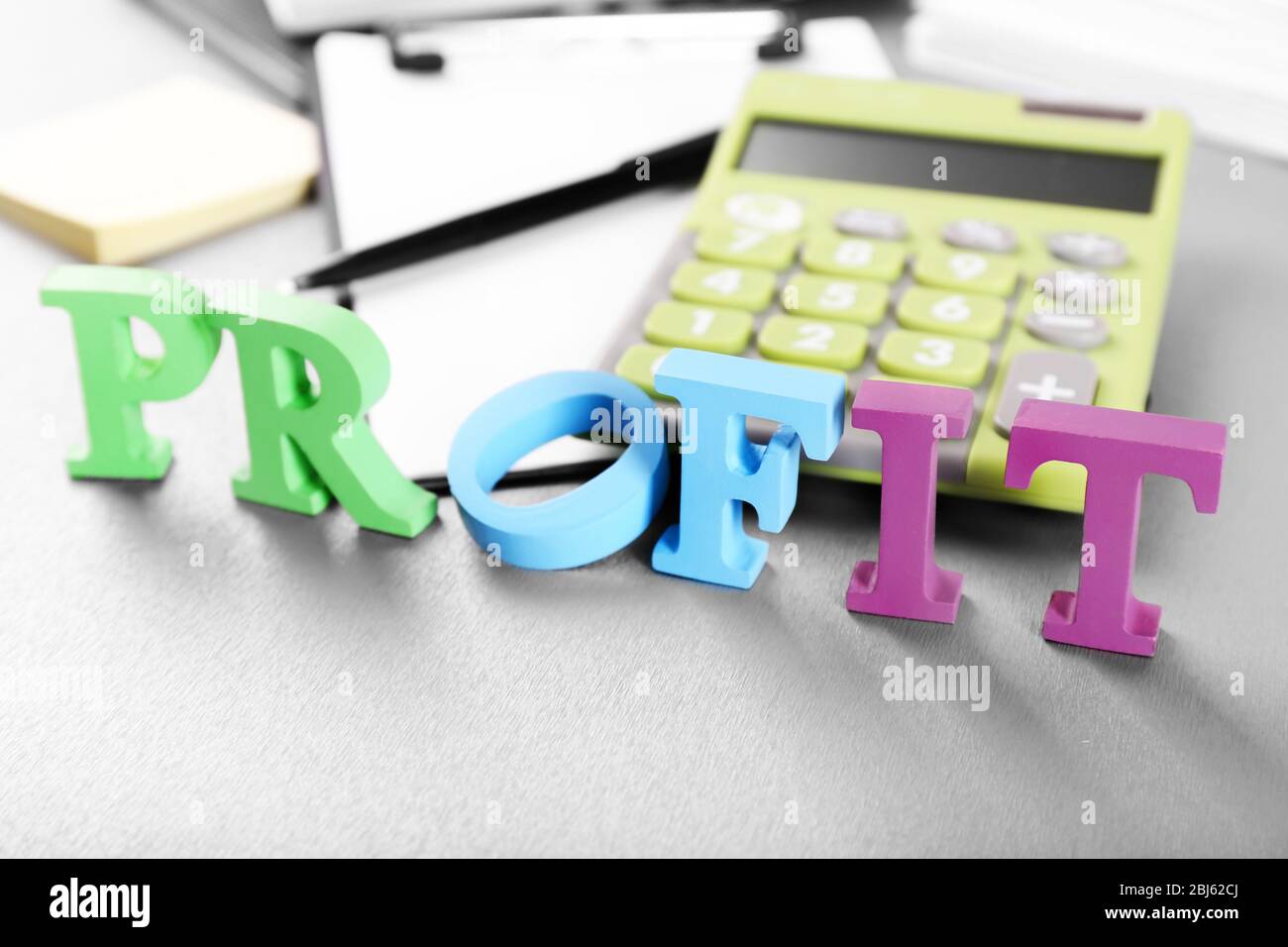 Alphabet Profit and calculator on table Stock Photo - Alamy