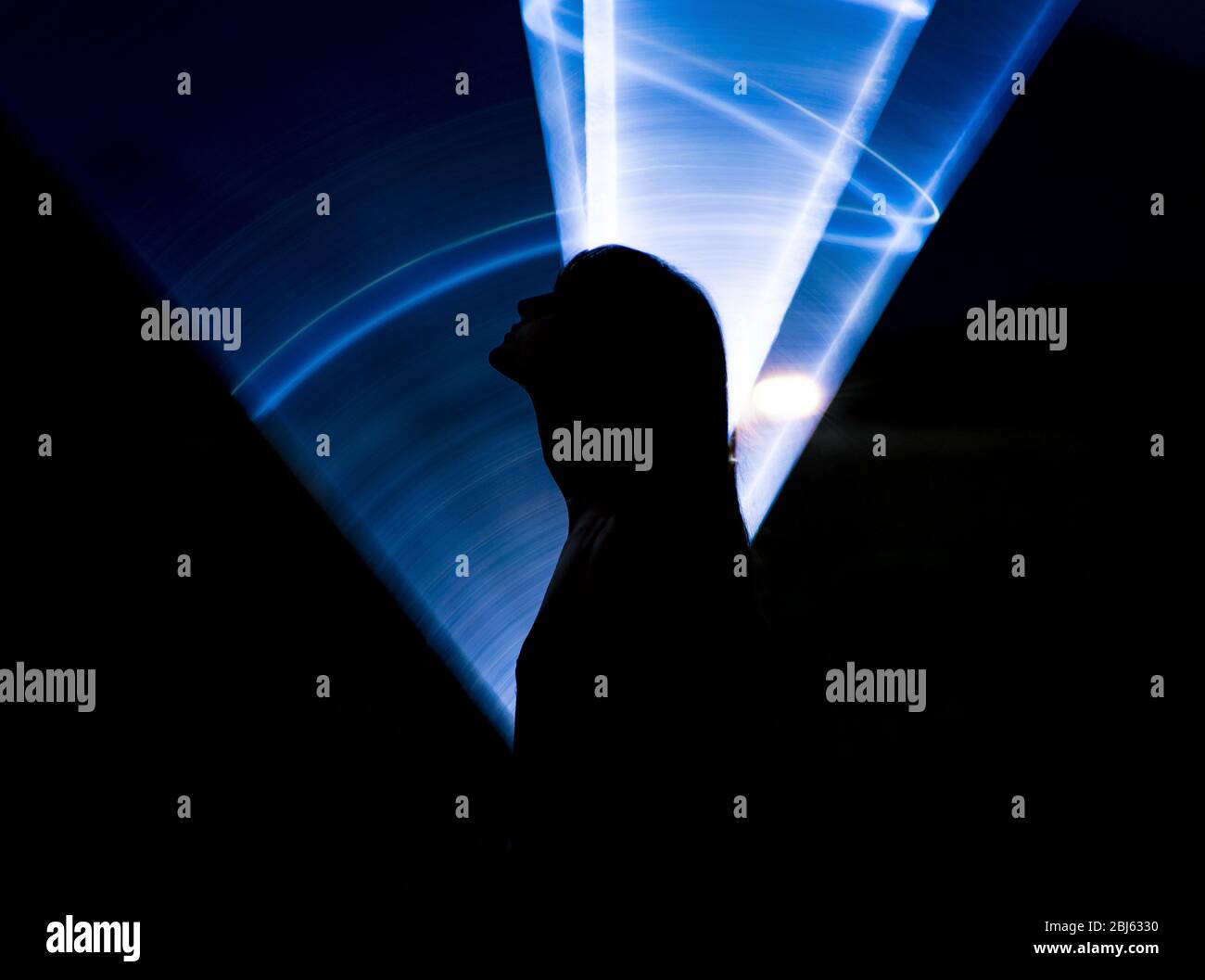 woman silhouette through blue light lightpainting Stock Photo - Alamy