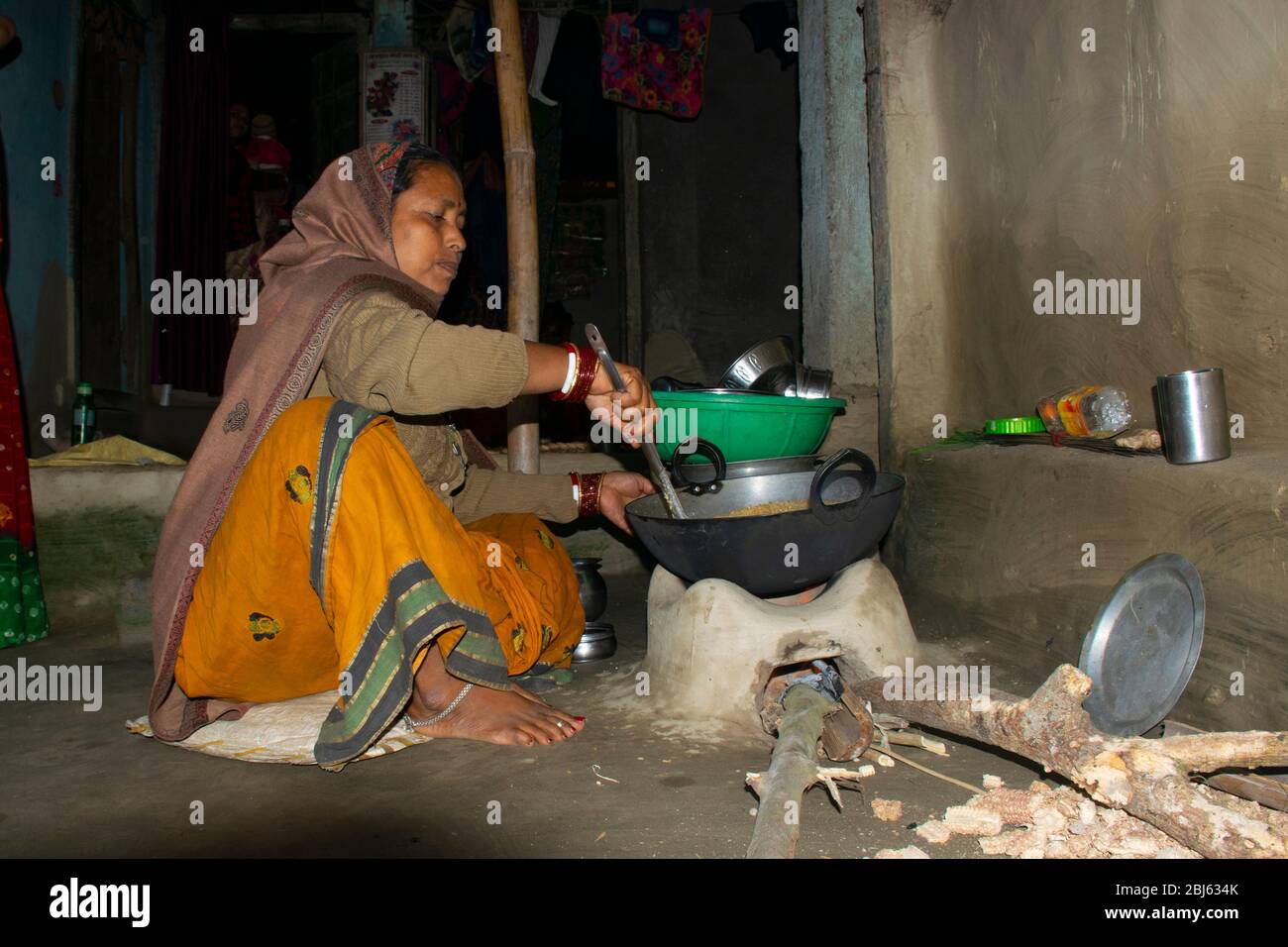 Rural Indian Woman cooking food in the Kitchen using firewood stove ...