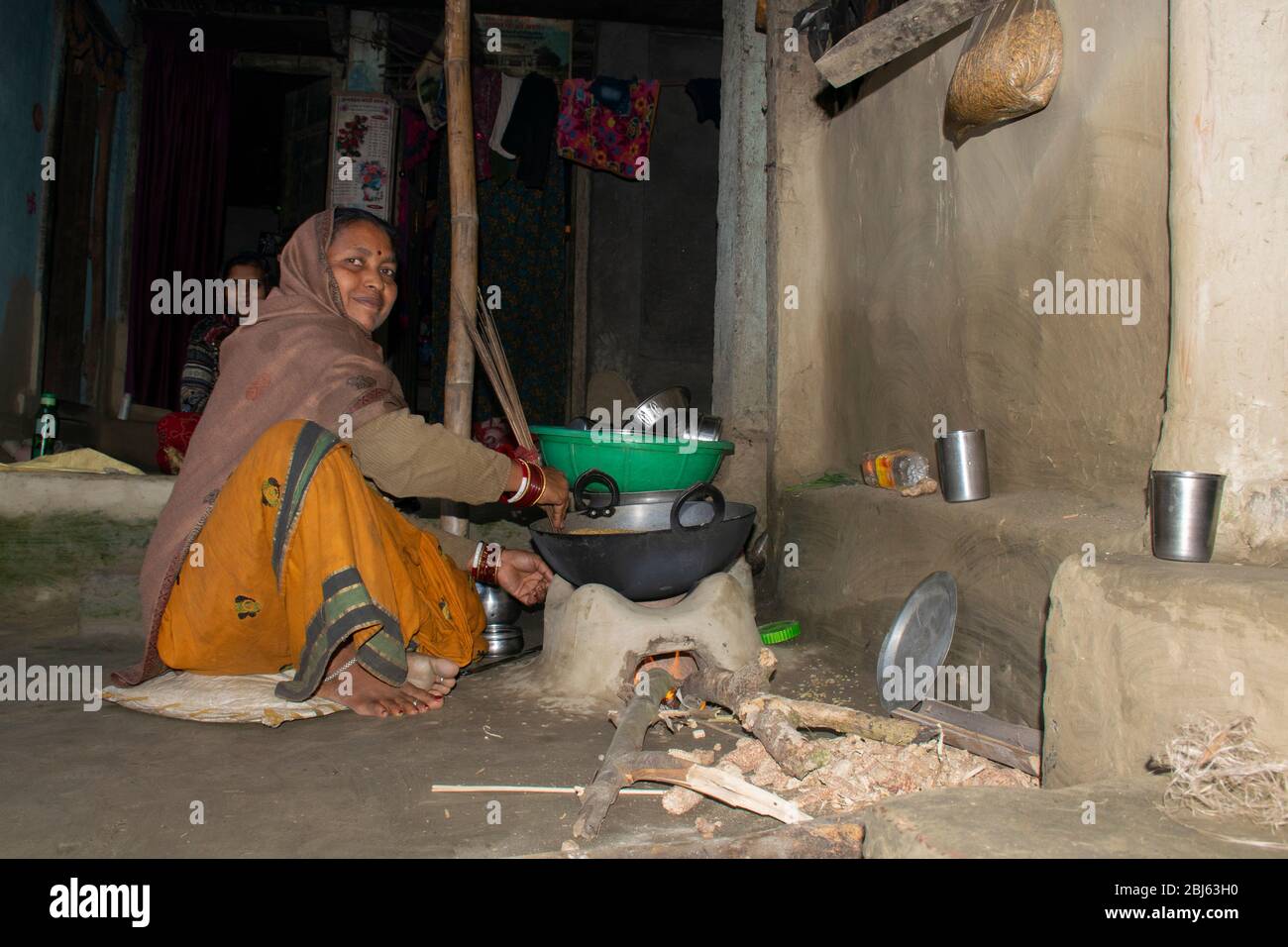 Rural Indian Woman cooking food in the Kitchen using firewood stove ...