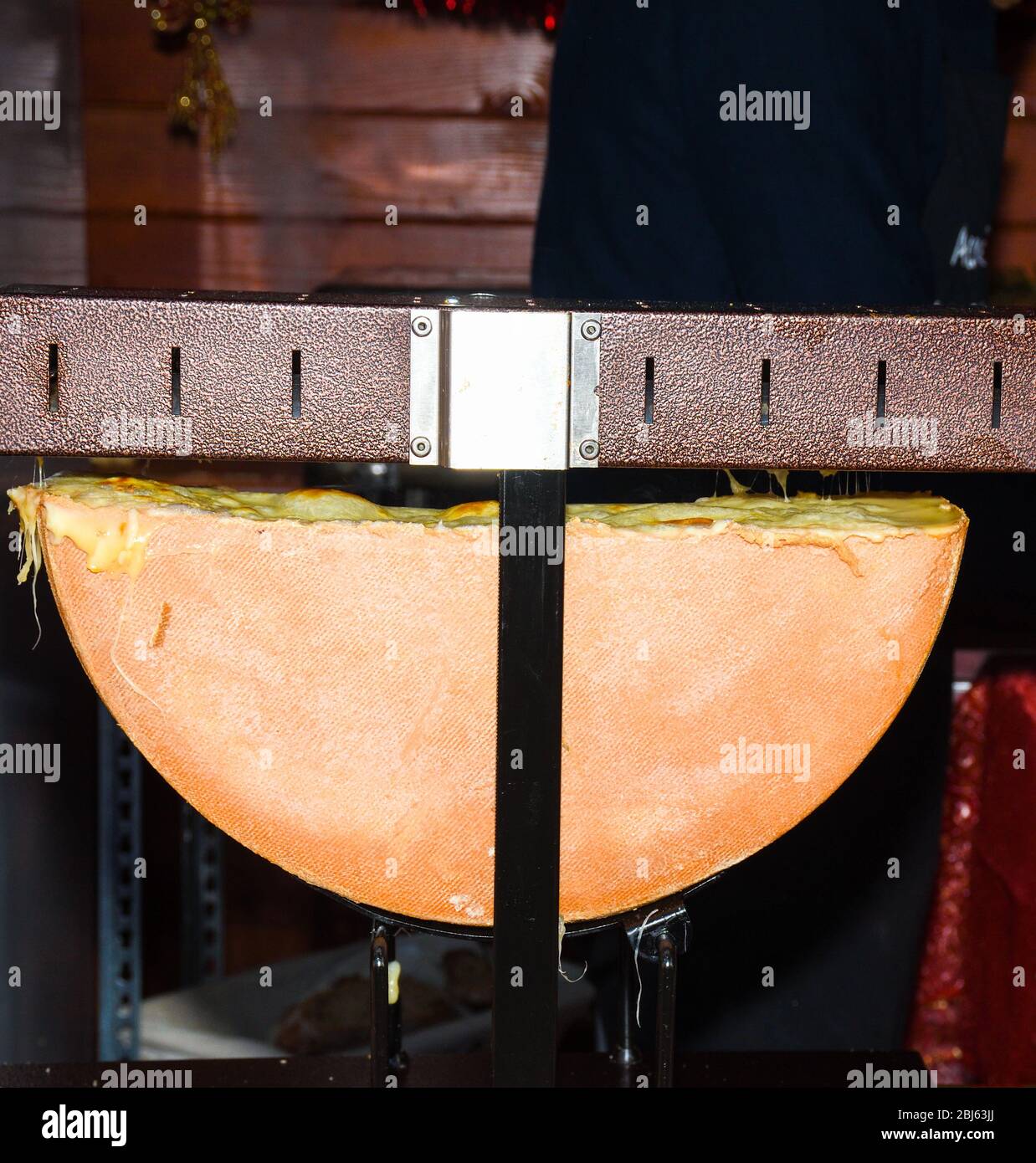 delicious salami raclette with hand and knife Stock Photo - Alamy