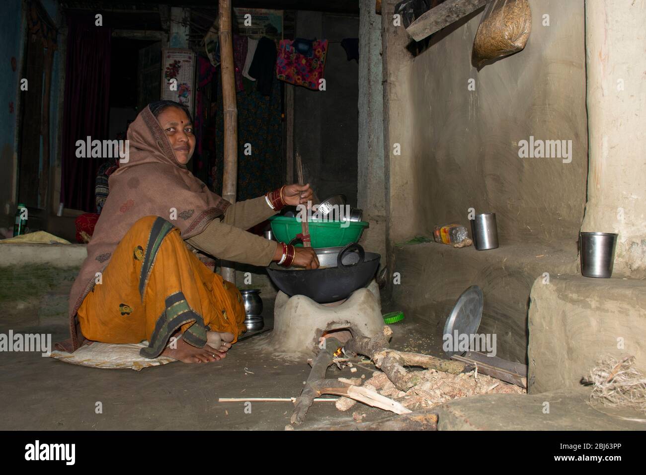 Rural Indian Woman cooking food in the Kitchen using firewood stove ...