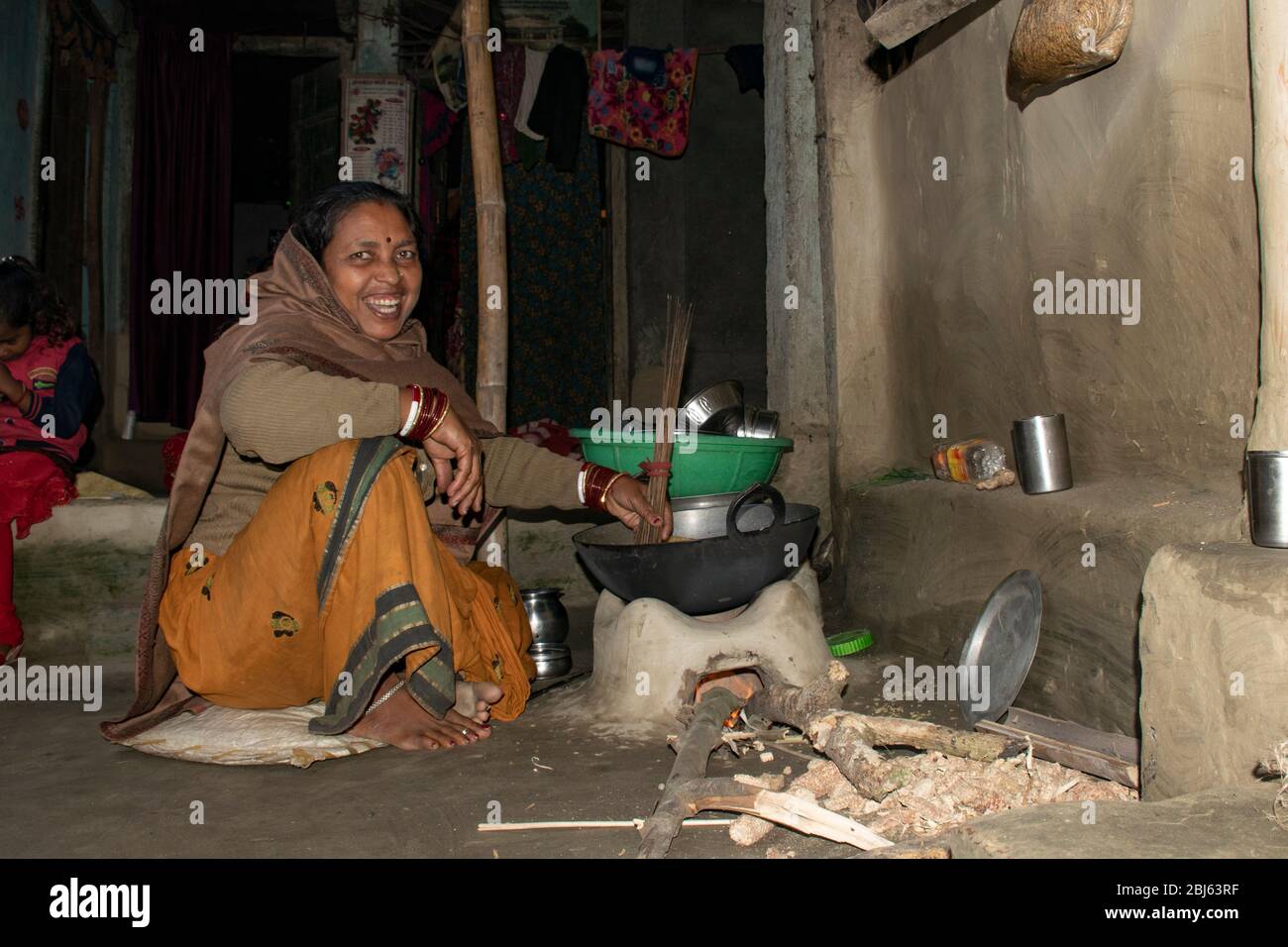 Rural Indian Woman cooking food in the Kitchen using firewood stove ...