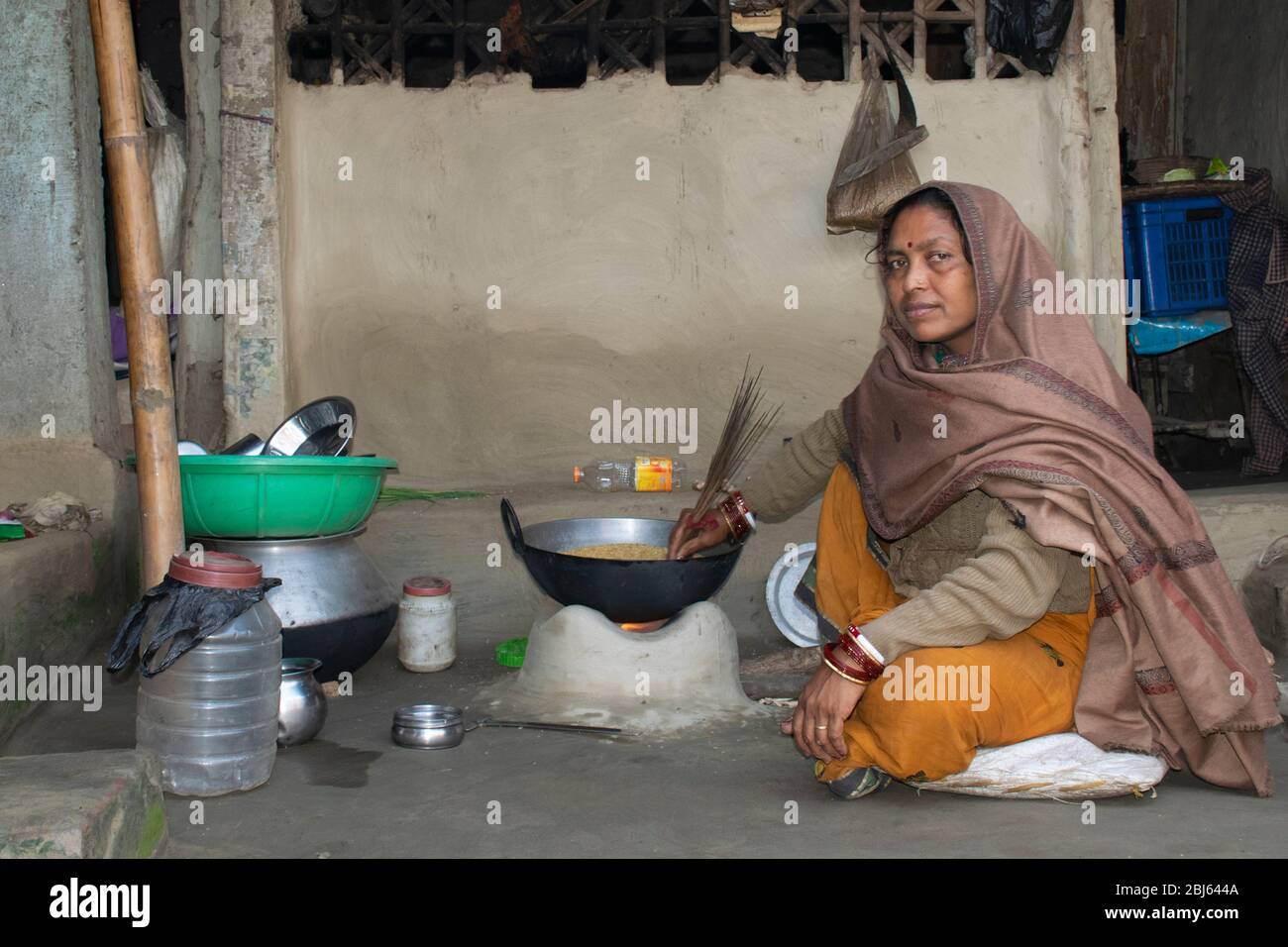 Rural Indian Woman cooking food in the Kitchen using firewood stove ...