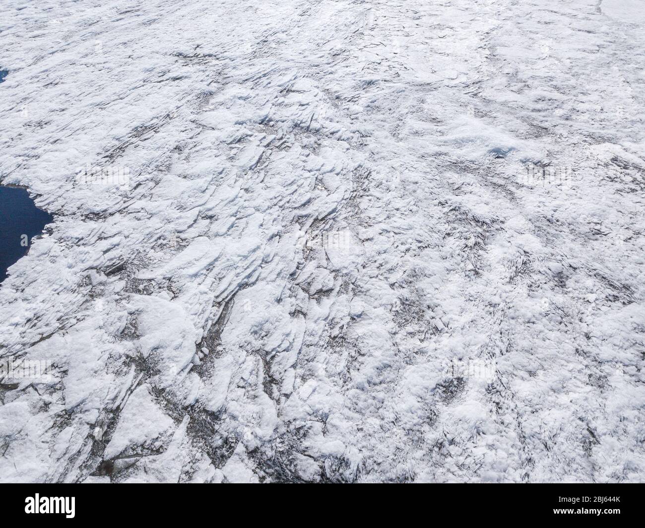 Aerial view of the ice texture broken into pieces of different shapes ...