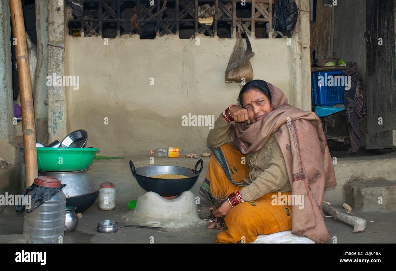 Rural Indian Woman crying while cooking food in the Kitchen using ...