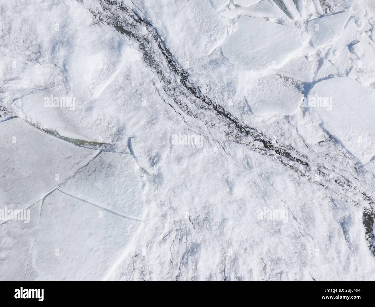 Aerial view of the ice texture broken into pieces of different shapes ...
