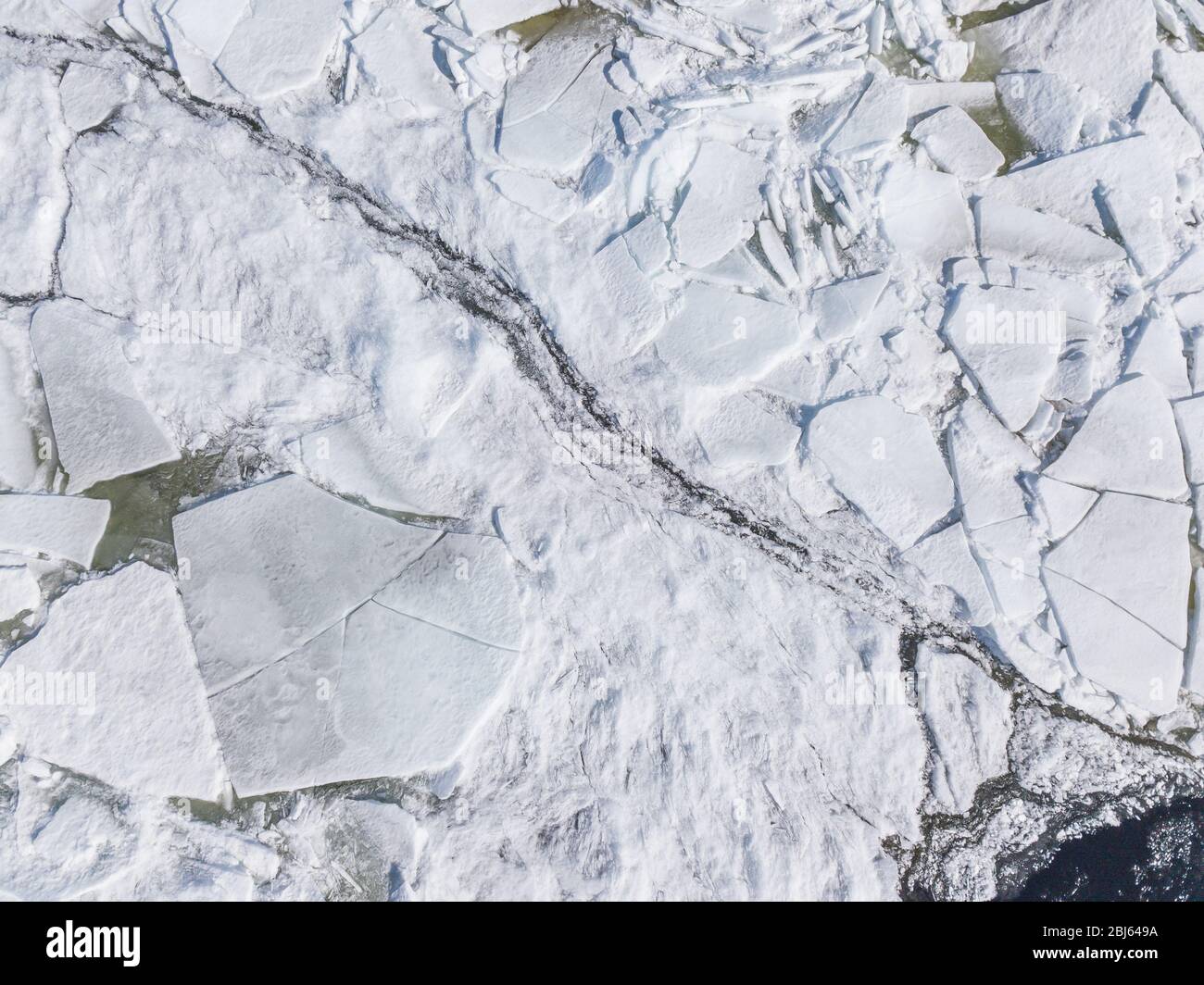 Aerial view of the ice texture broken into pieces of different shapes ...
