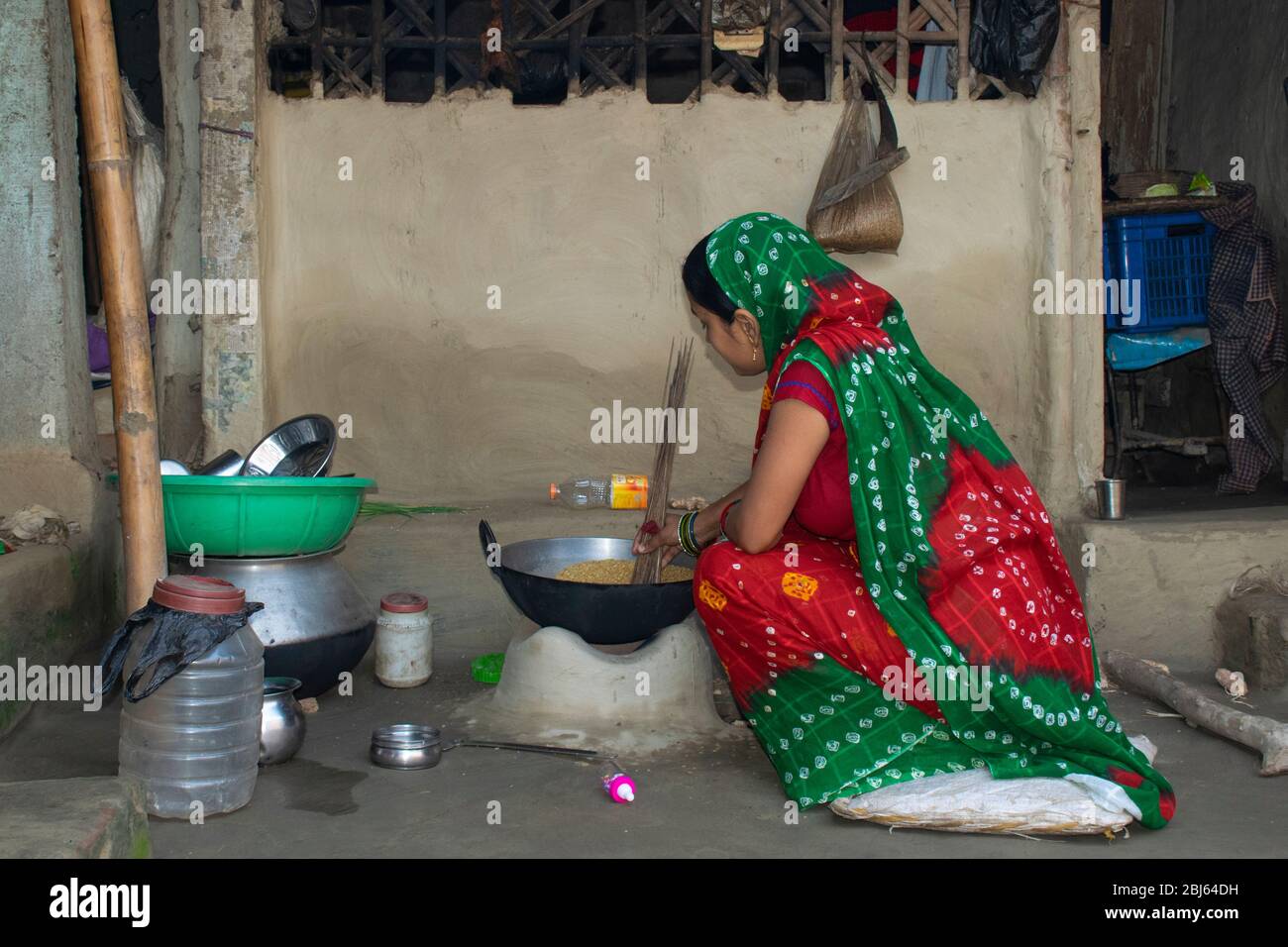 Rural Indian Woman cooking food in the Kitchen using firewood stove ...
