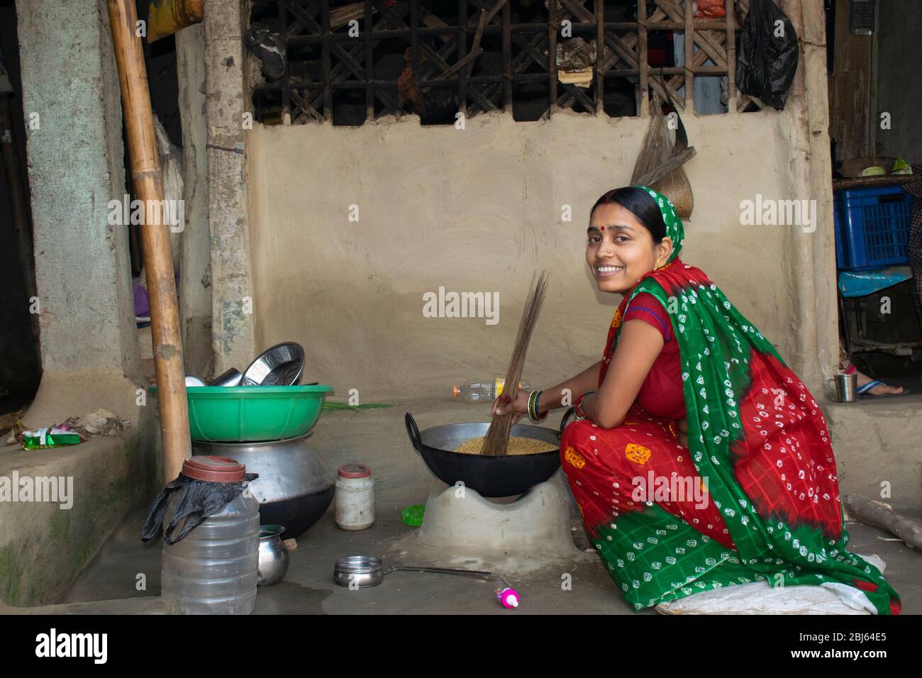 Rural Indian Woman Cooking Food In The Kitchen Using Firewood Stove