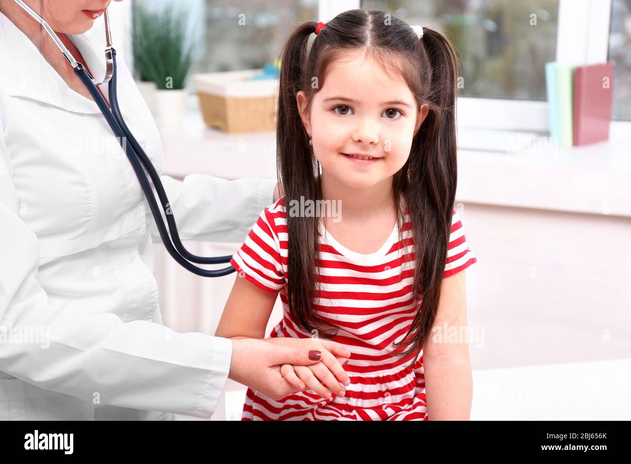 Doctor examining a child in the office Stock Photo - Alamy