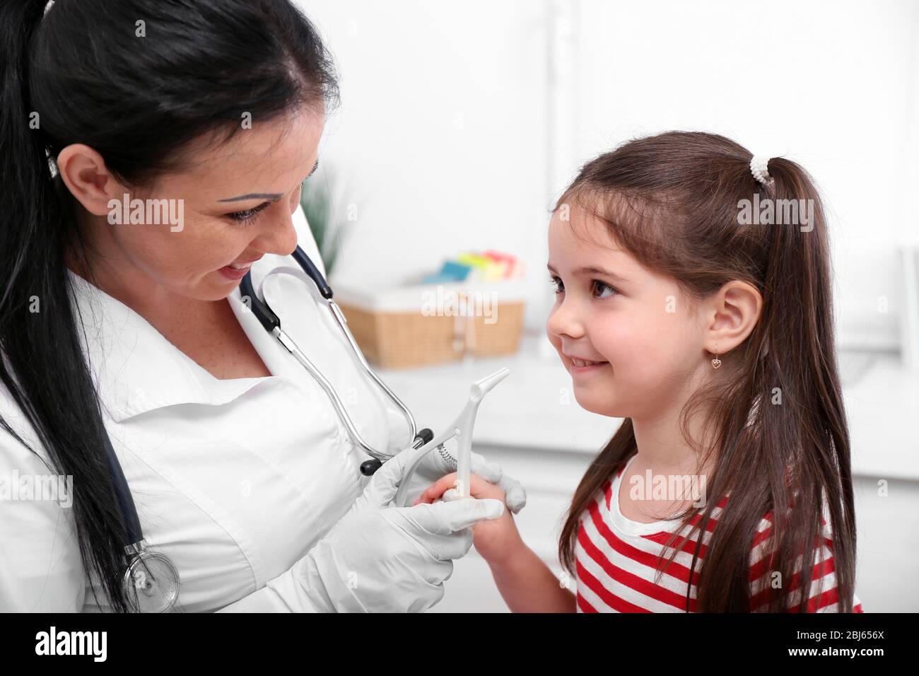 Doctor examining child's nose Stock Photo - Alamy