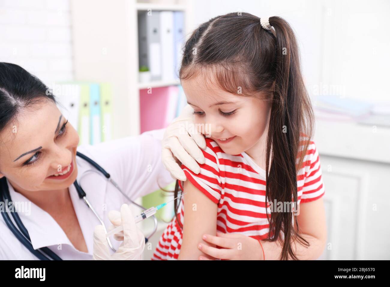 Doctor giving a child injection in the office Stock Photo - Alamy