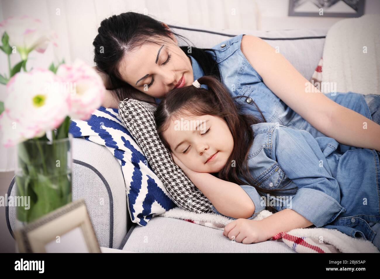 Mother and daughter sleeping on the sofa Stock Photo - Alamy