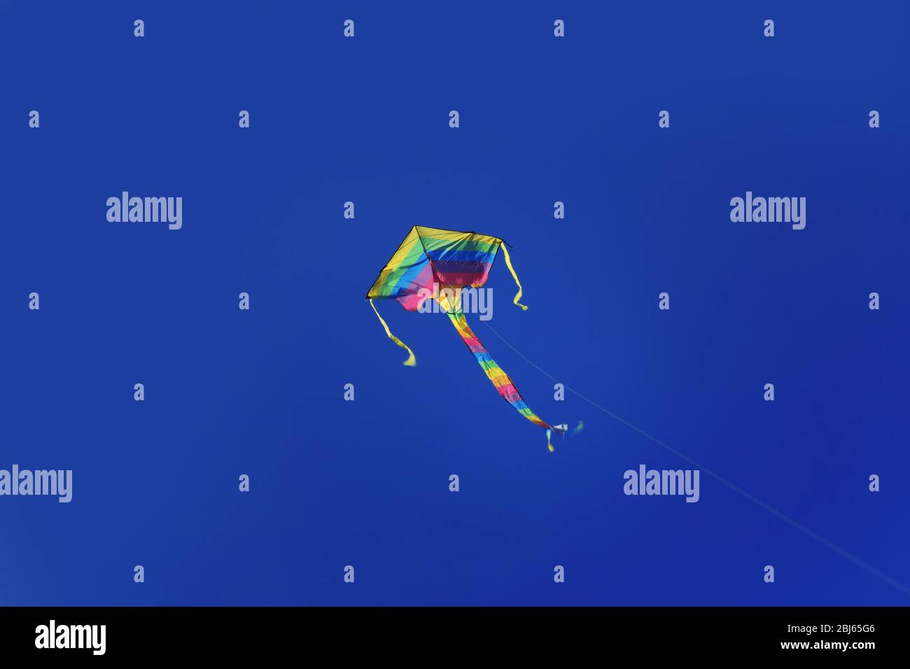 Kite in dark blue sky background Stock Photo - Alamy