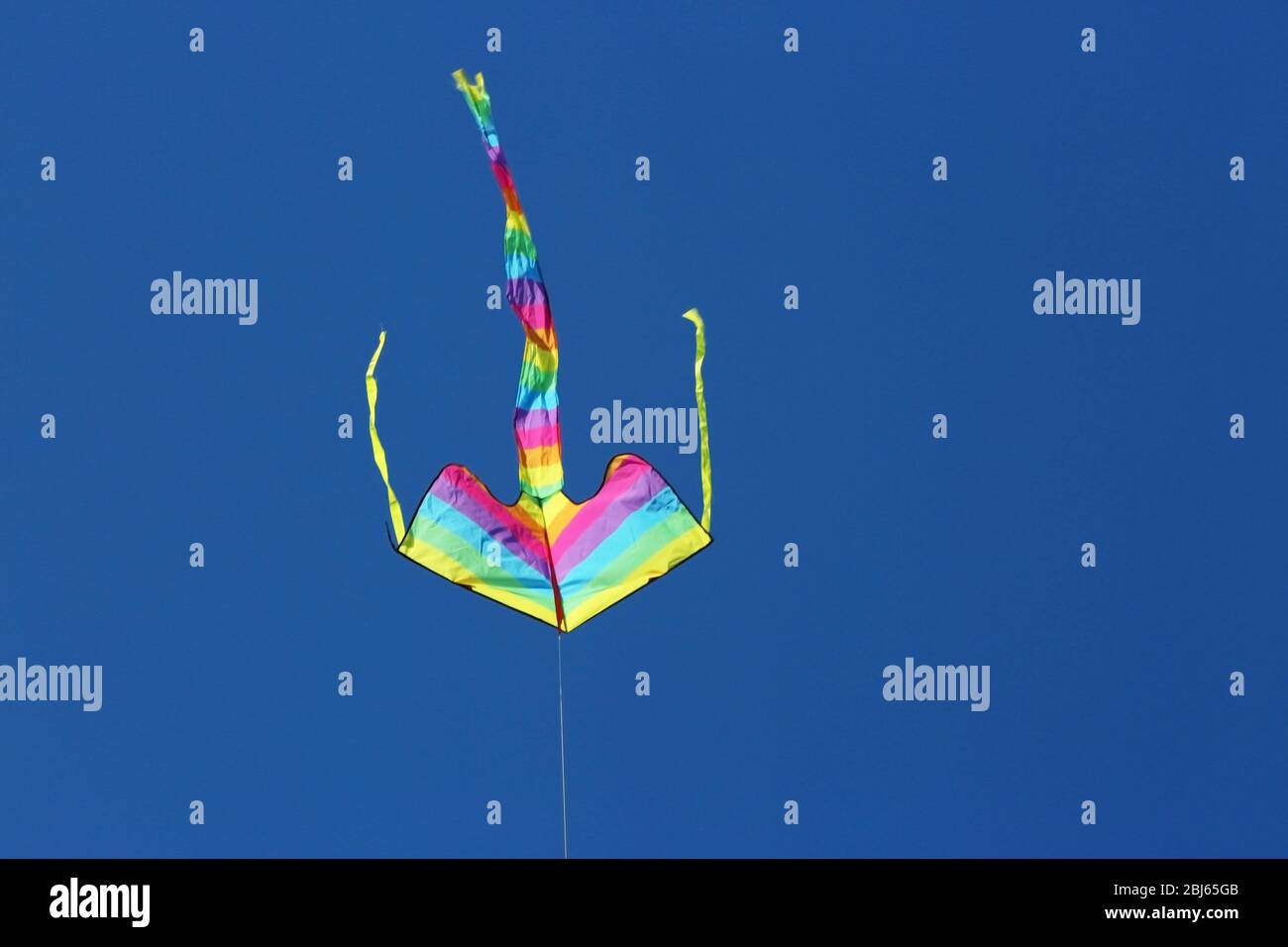 Kite in dark blue sky background Stock Photo - Alamy