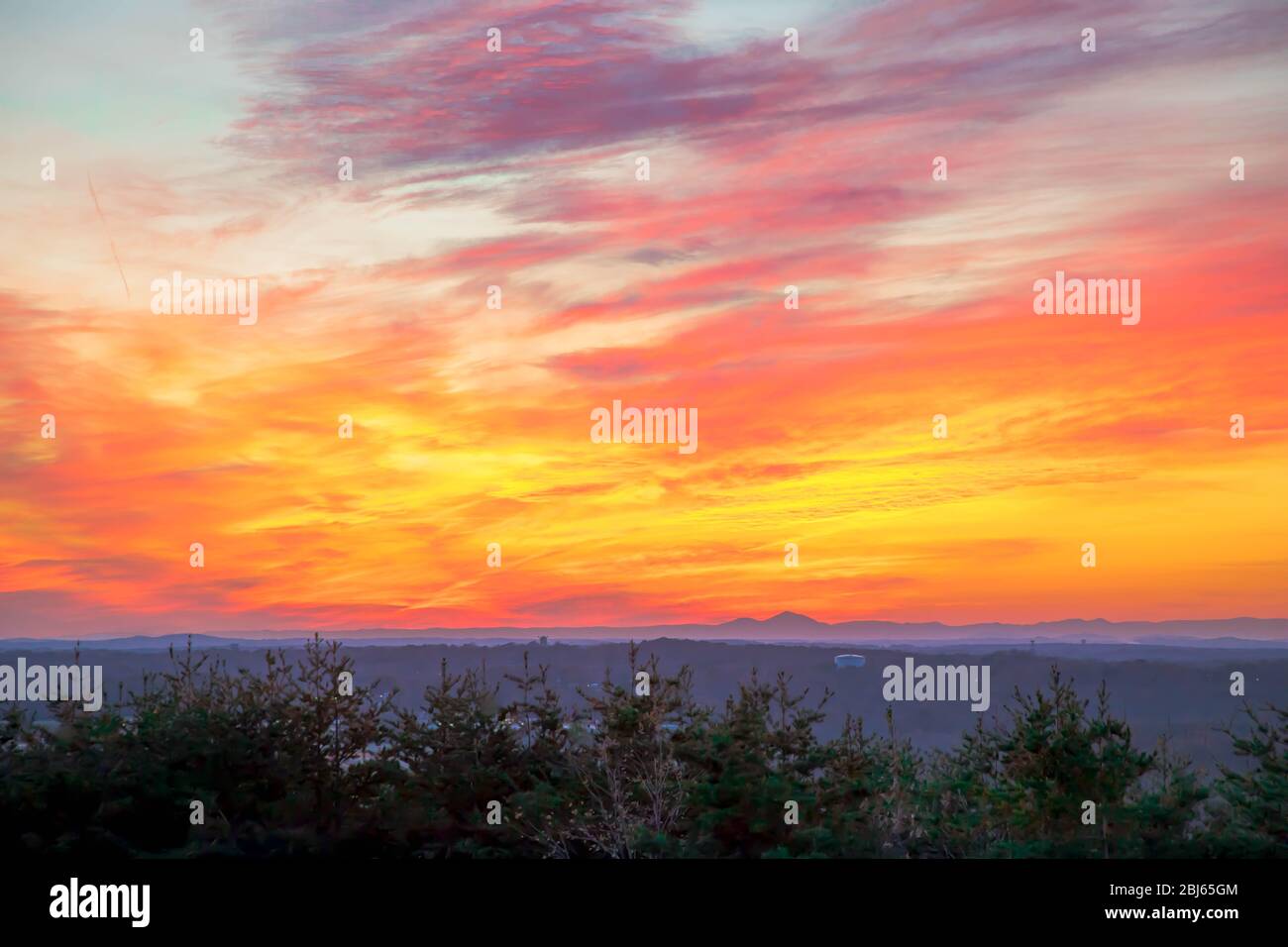 Colorful clouds sunset over the mountains Stock Photo - Alamy