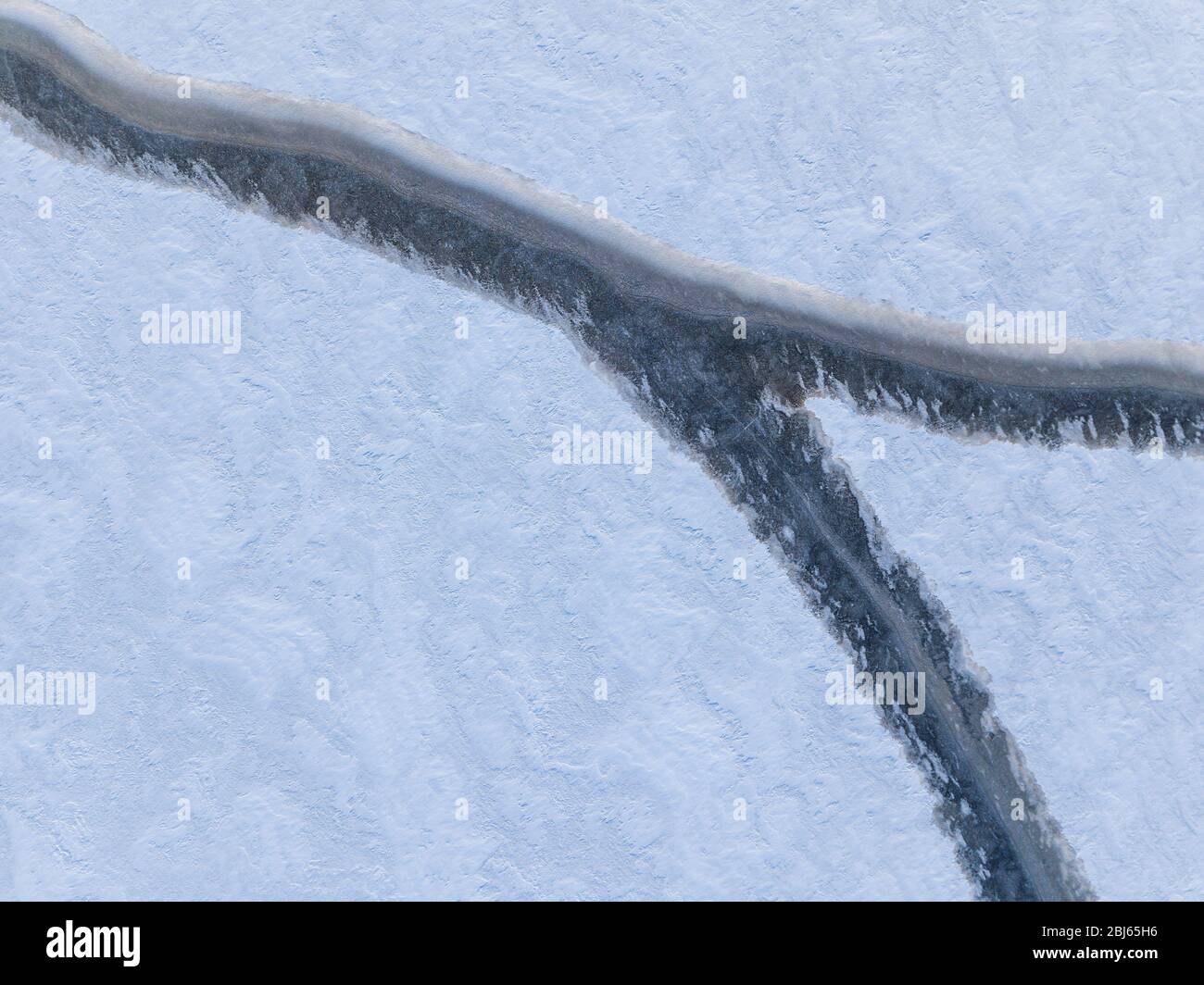 Aerial view of a rift on the ice of a winter lake Stock Photo - Alamy
