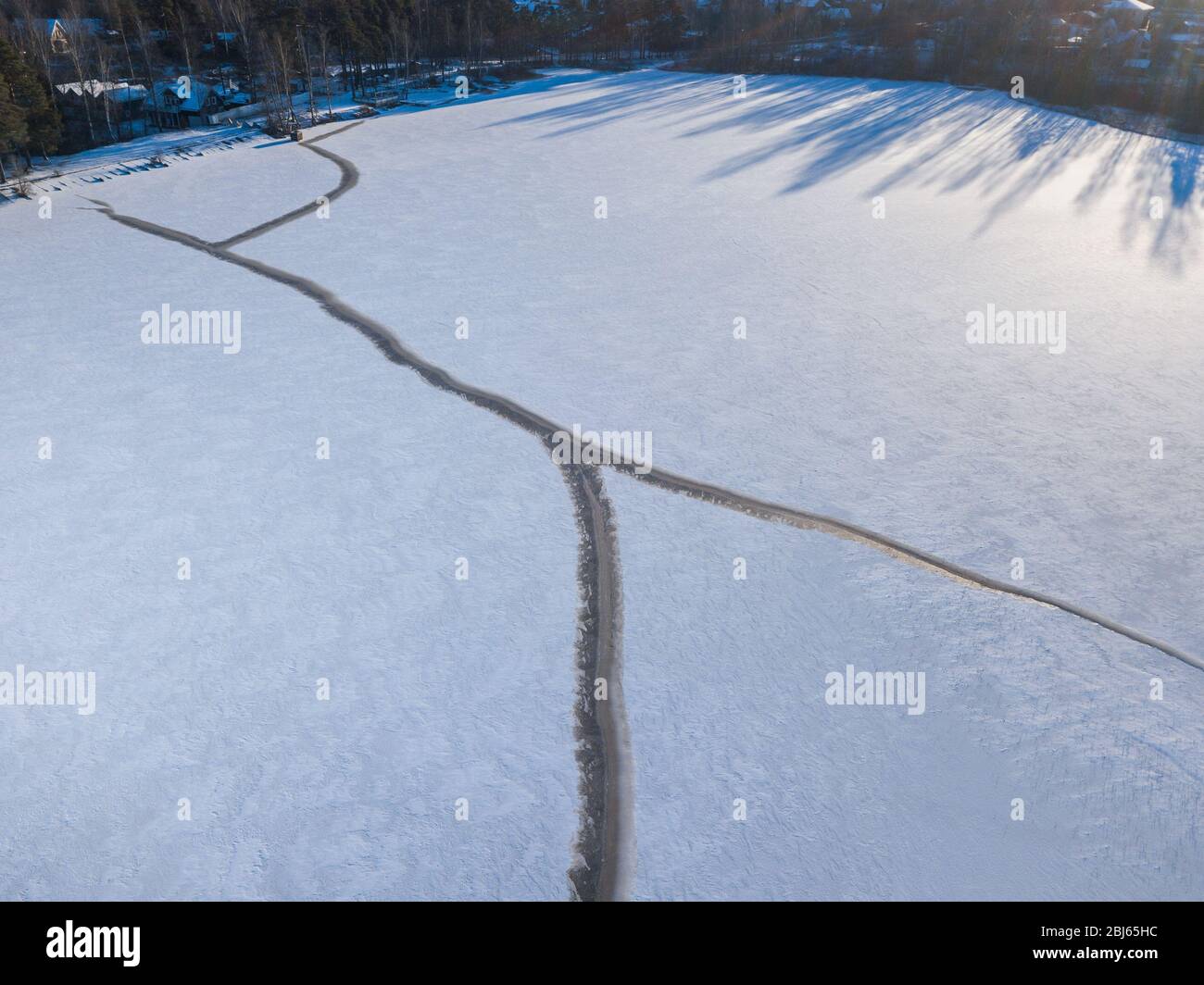 Aerial view of a rift on the ice of a winter lake Stock Photo - Alamy