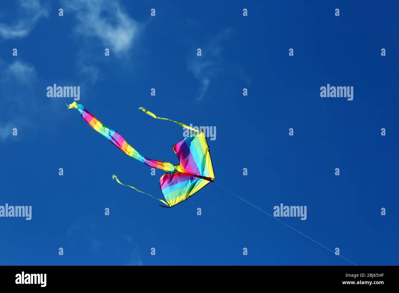 Kite in dark blue sky background Stock Photo - Alamy