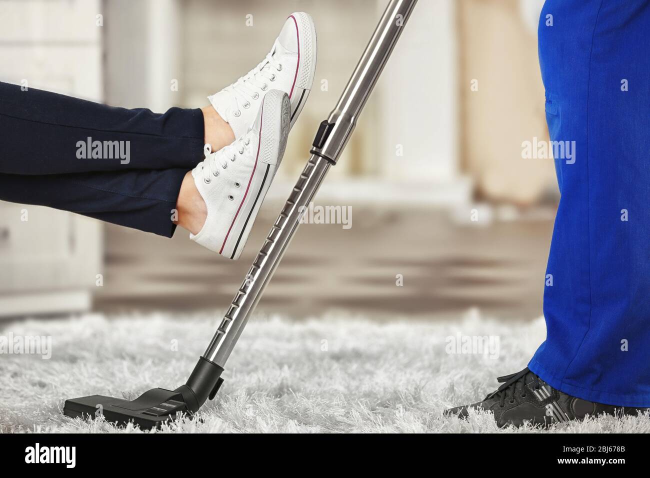 Cleaning concept - man cleaning the room with carpet sweeper, close up ...